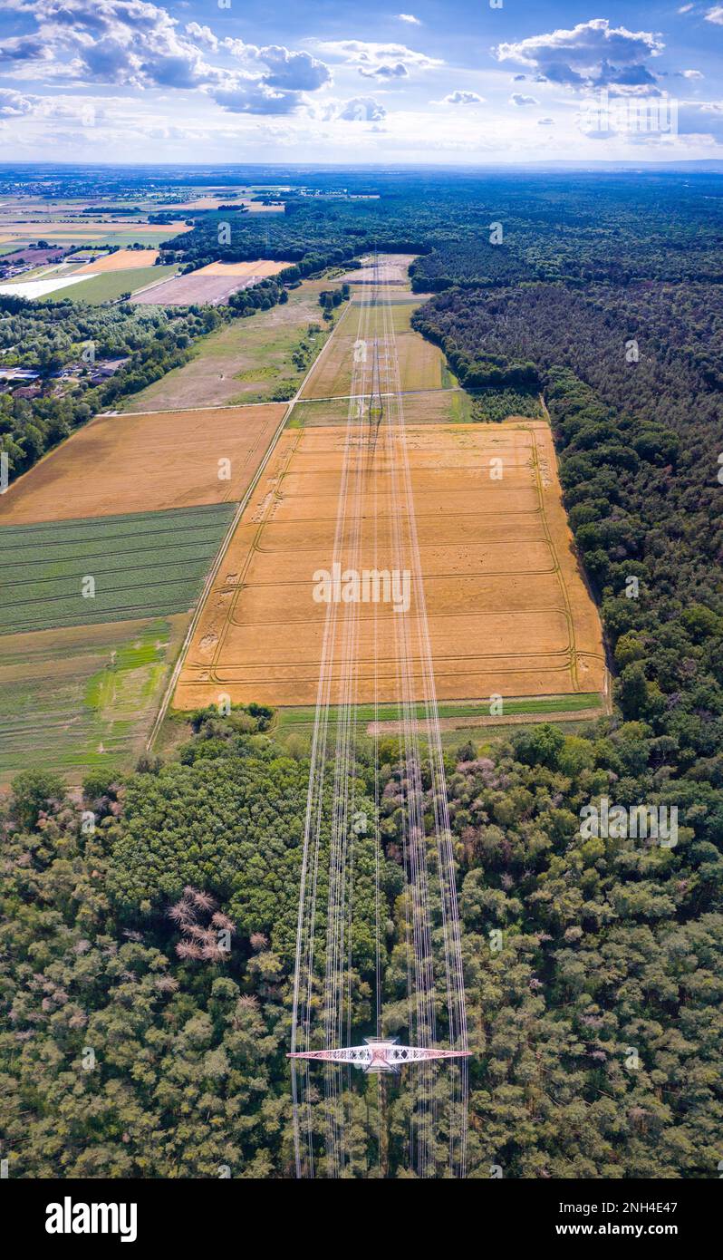 Aerial view along a power line in forest area with metal power poles ...