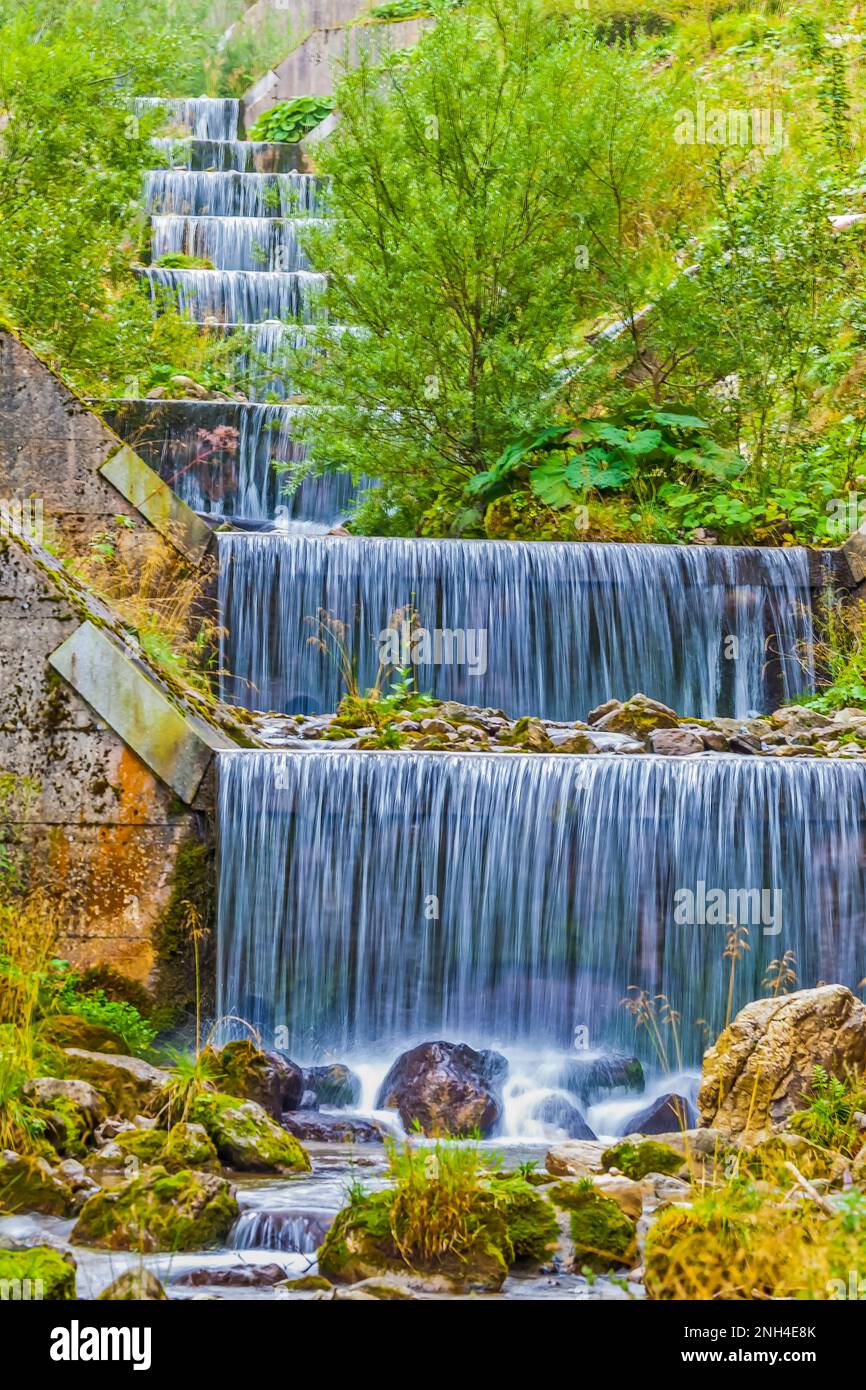 Photograph of a water cascade in long exposure during the day in summer ...