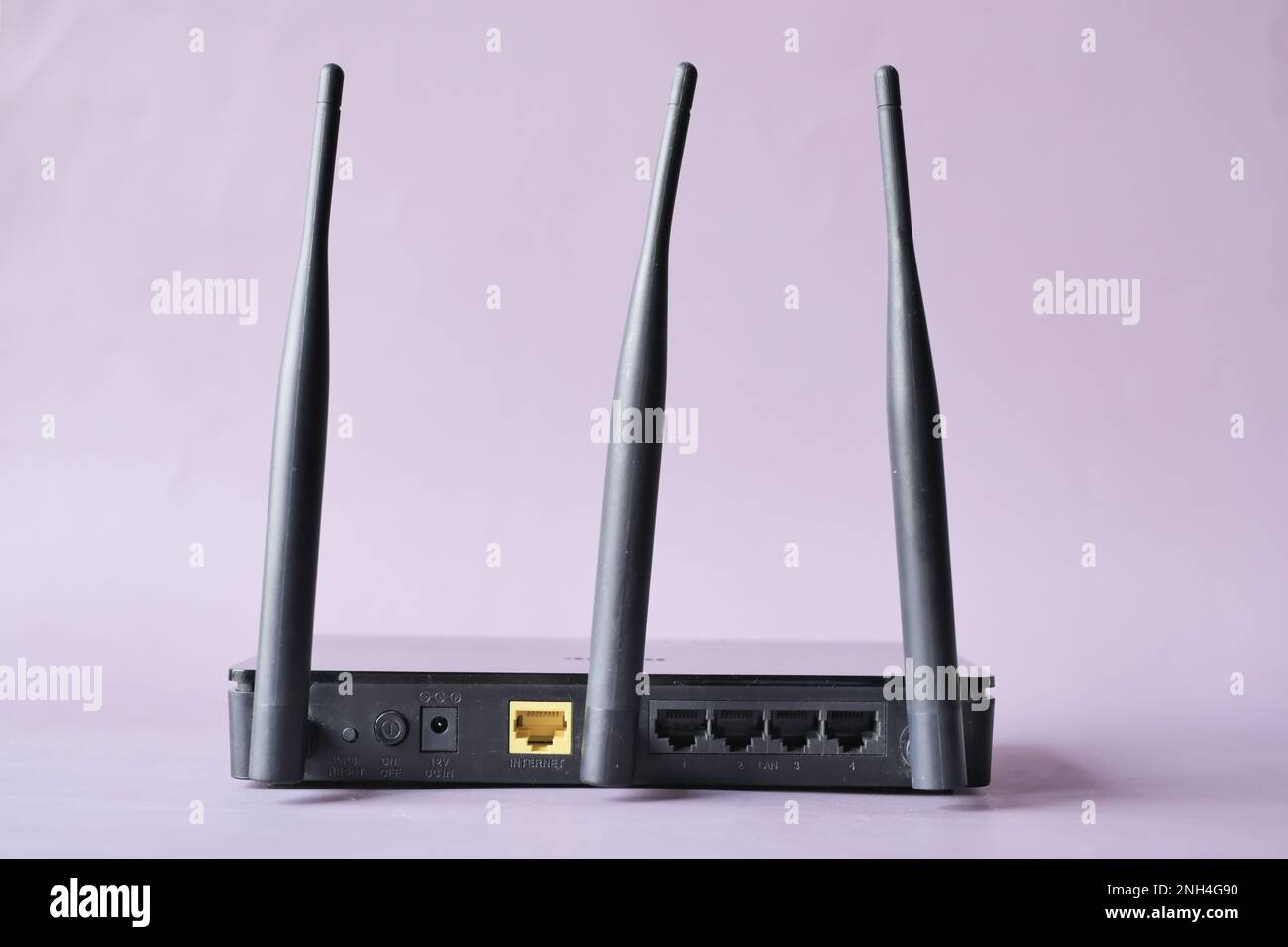 Wi-Fi router with cables on table Stock Photo - Alamy