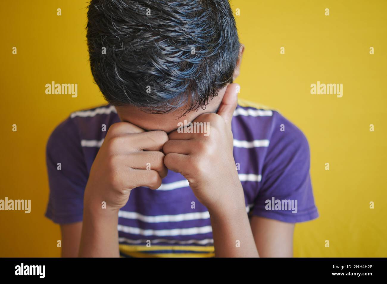 a asian boy crying sitting on chair Stock Photo - Alamy