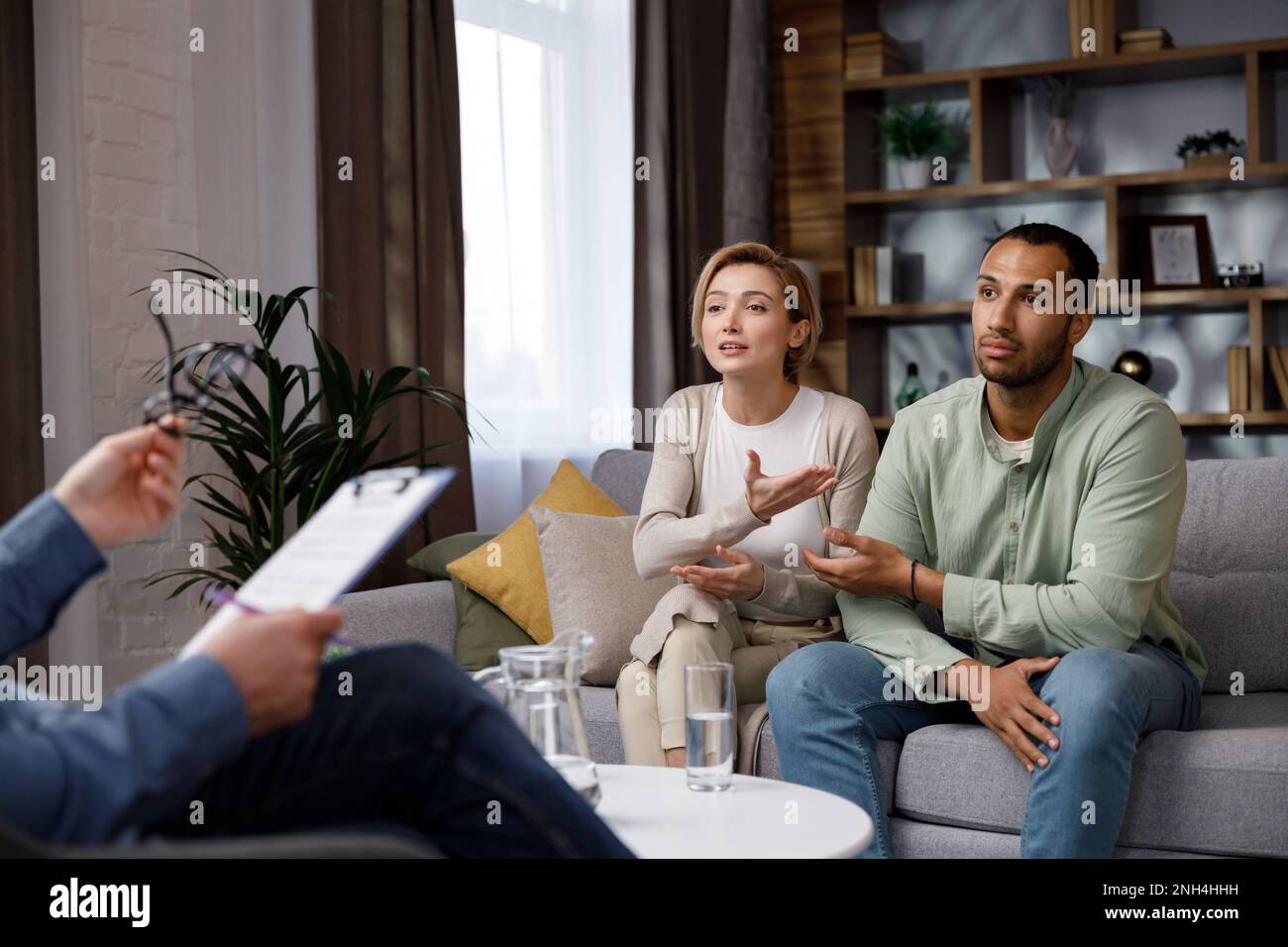 Multiracial quarrel between husband and wife at a session with a ...