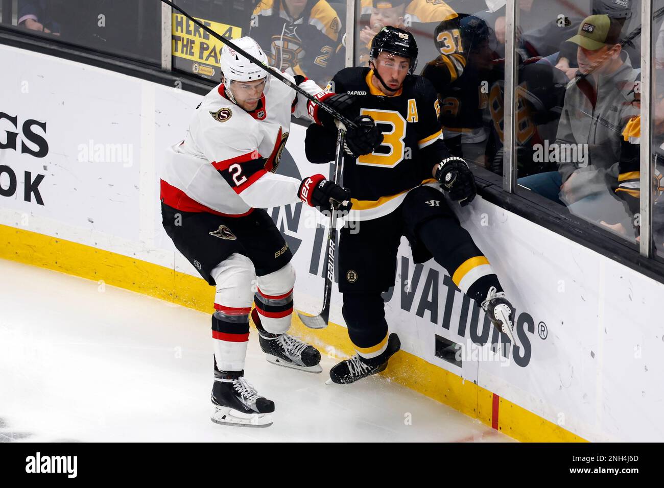 Ottawa Senators' Artem Zub (2) checks Boston Bruins' Brad Marchand (63 ...