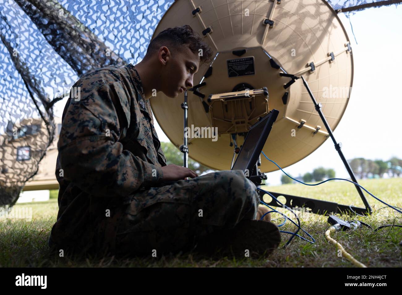 U.S. Marine Corps Cpl. Ronald Garcia, a satellite transmission system ...