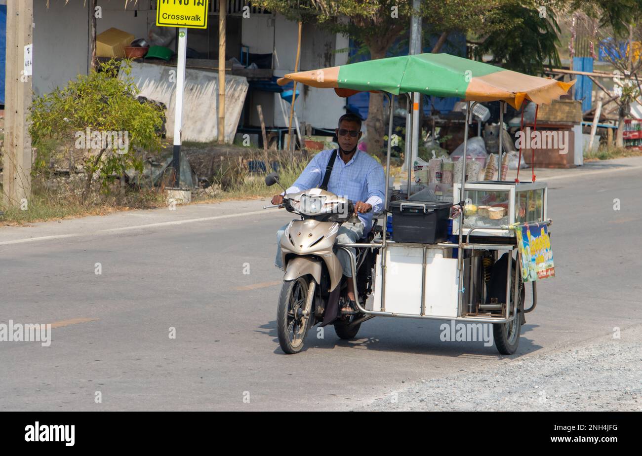 SAMUT PRAKAN, THAILAND, FEB 01 2023, An ice cream vendor rides a three ...