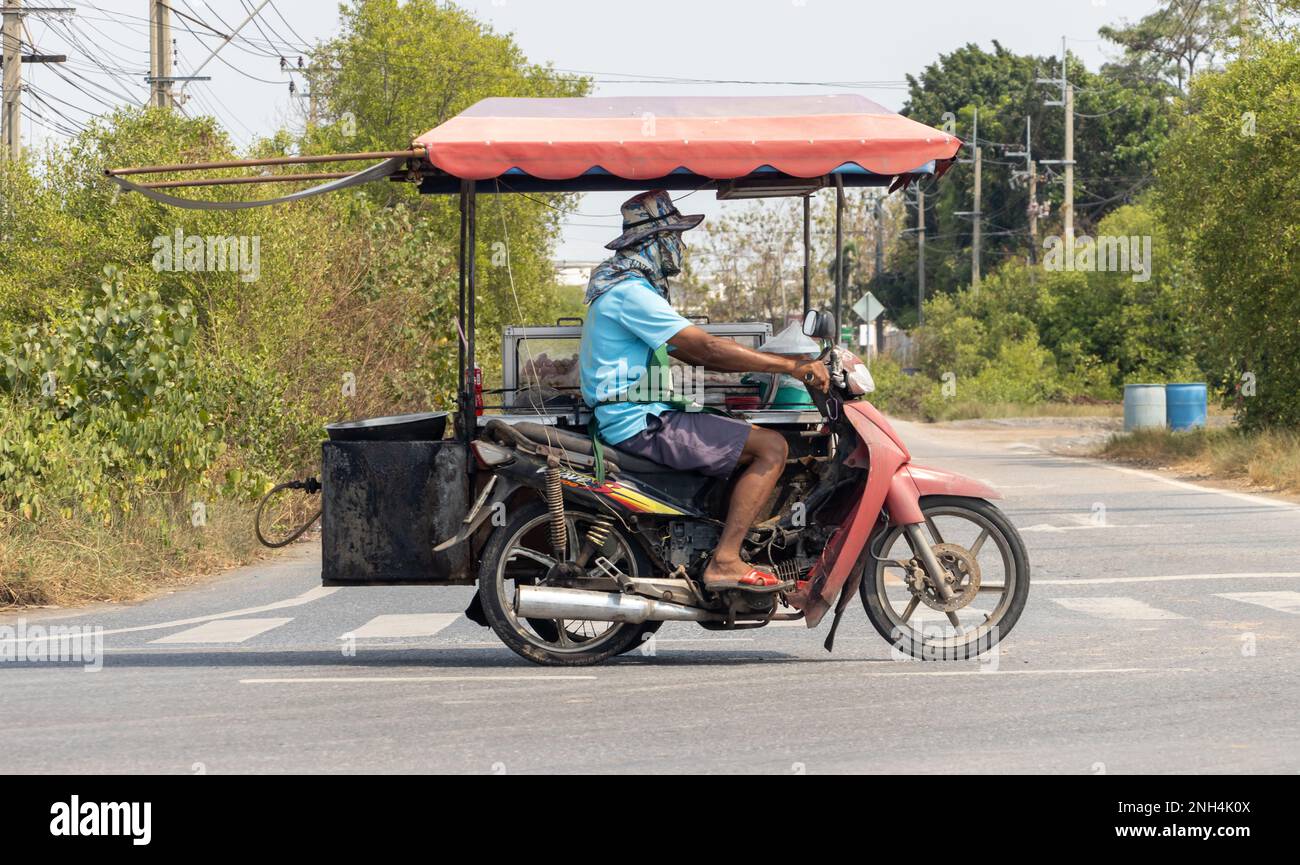 BANGKOK, THAILAND, FEB 07 2023, A food seller drives a sidecar on the ...