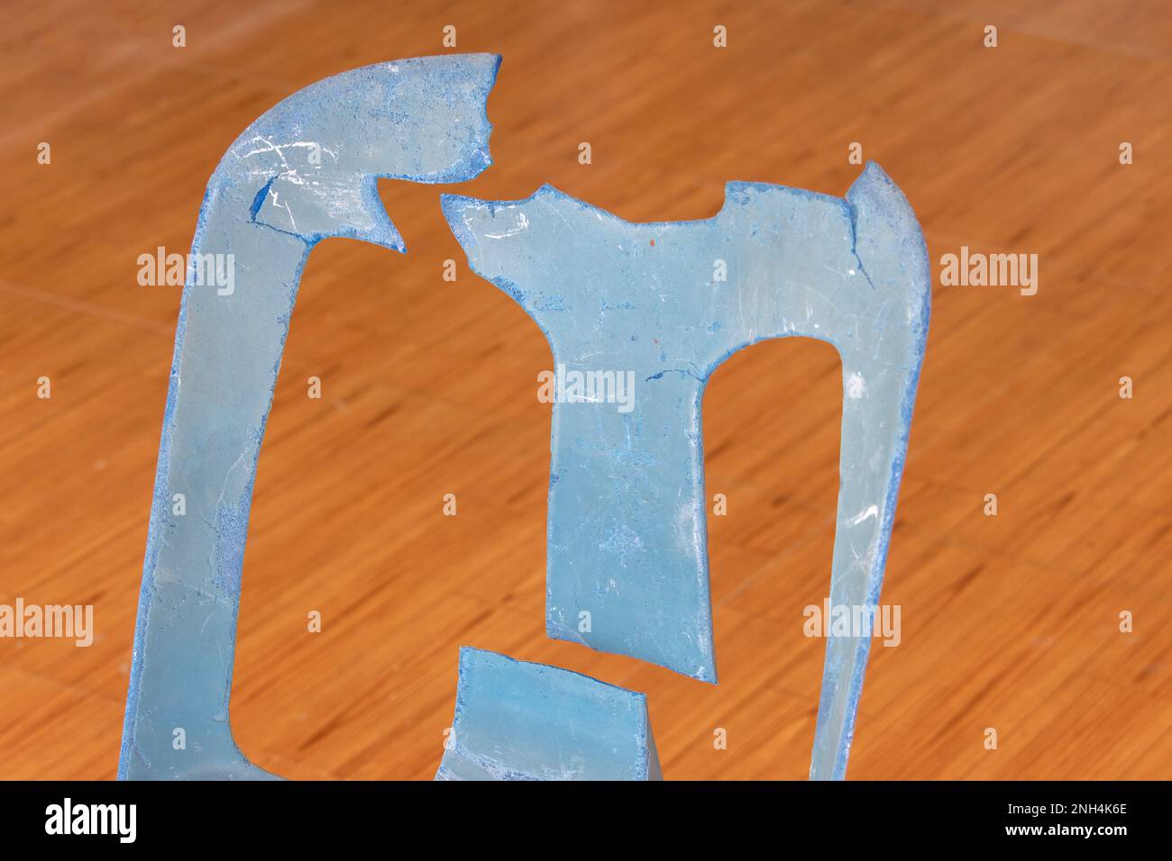 A broken plastic chair on the tiled floor, close up Stock Photo - Alamy