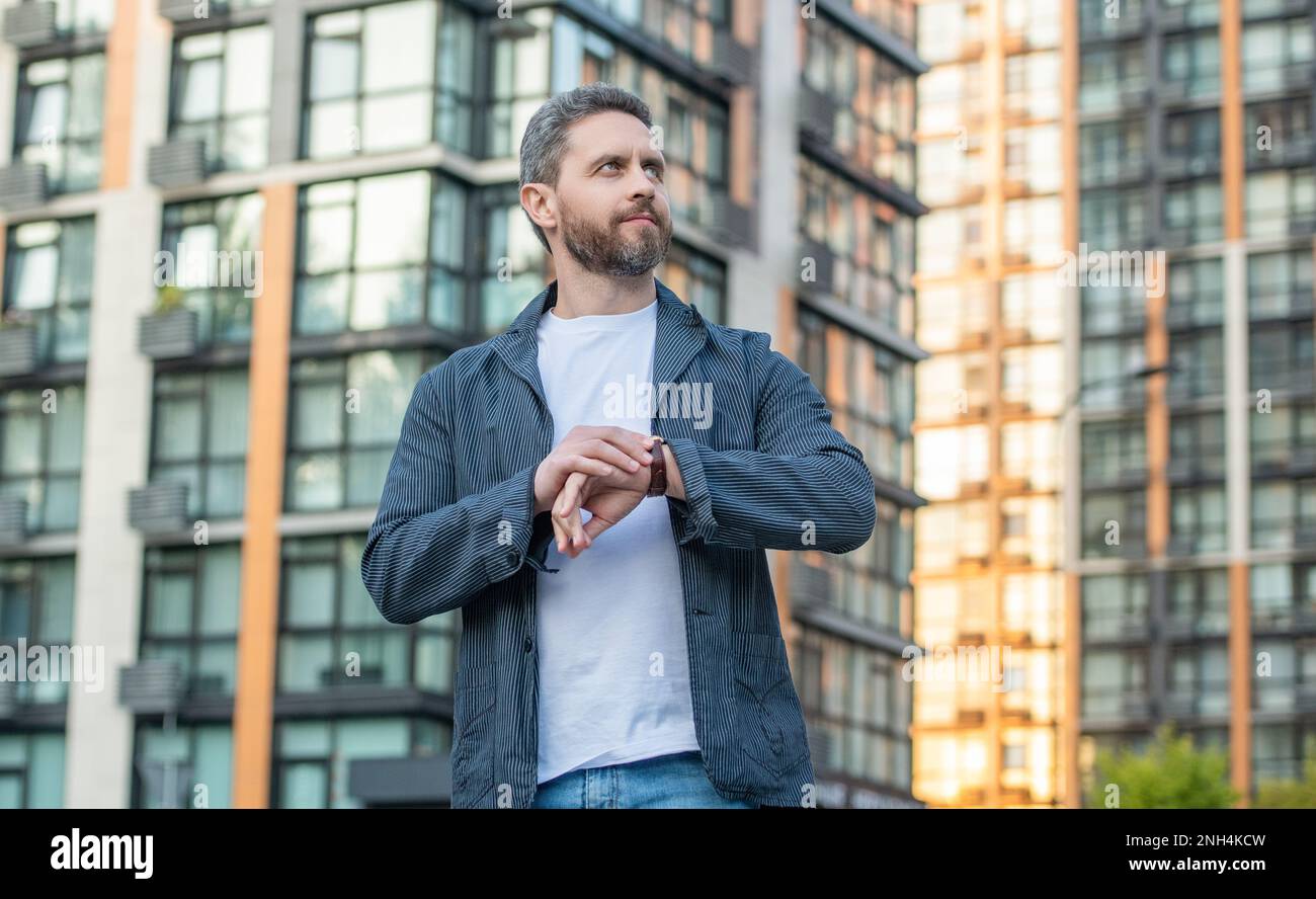 punctual man check time outside. photo of punctual man check time on ...
