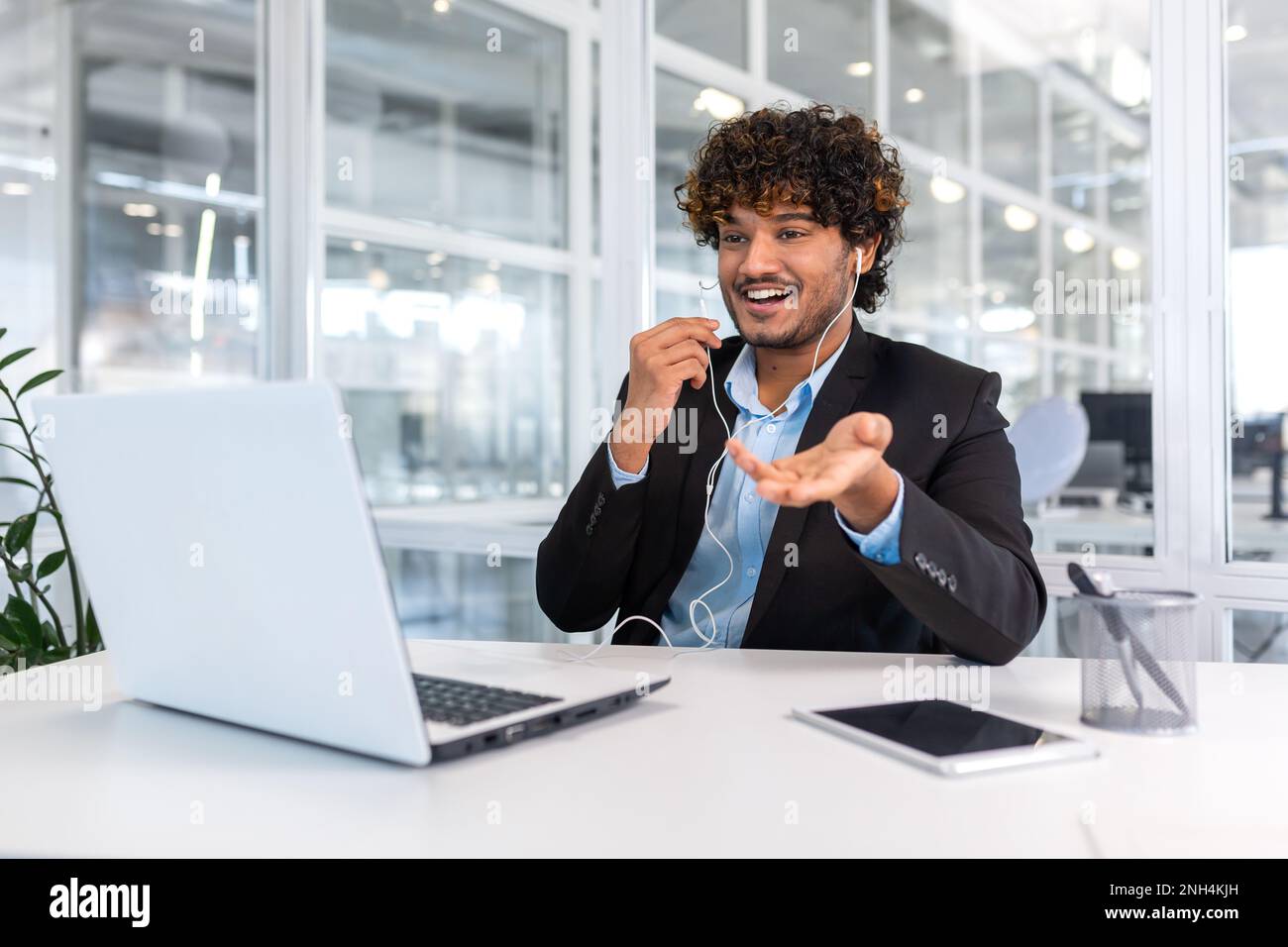 Young successful hispanic businessman boss talking on video call ...
