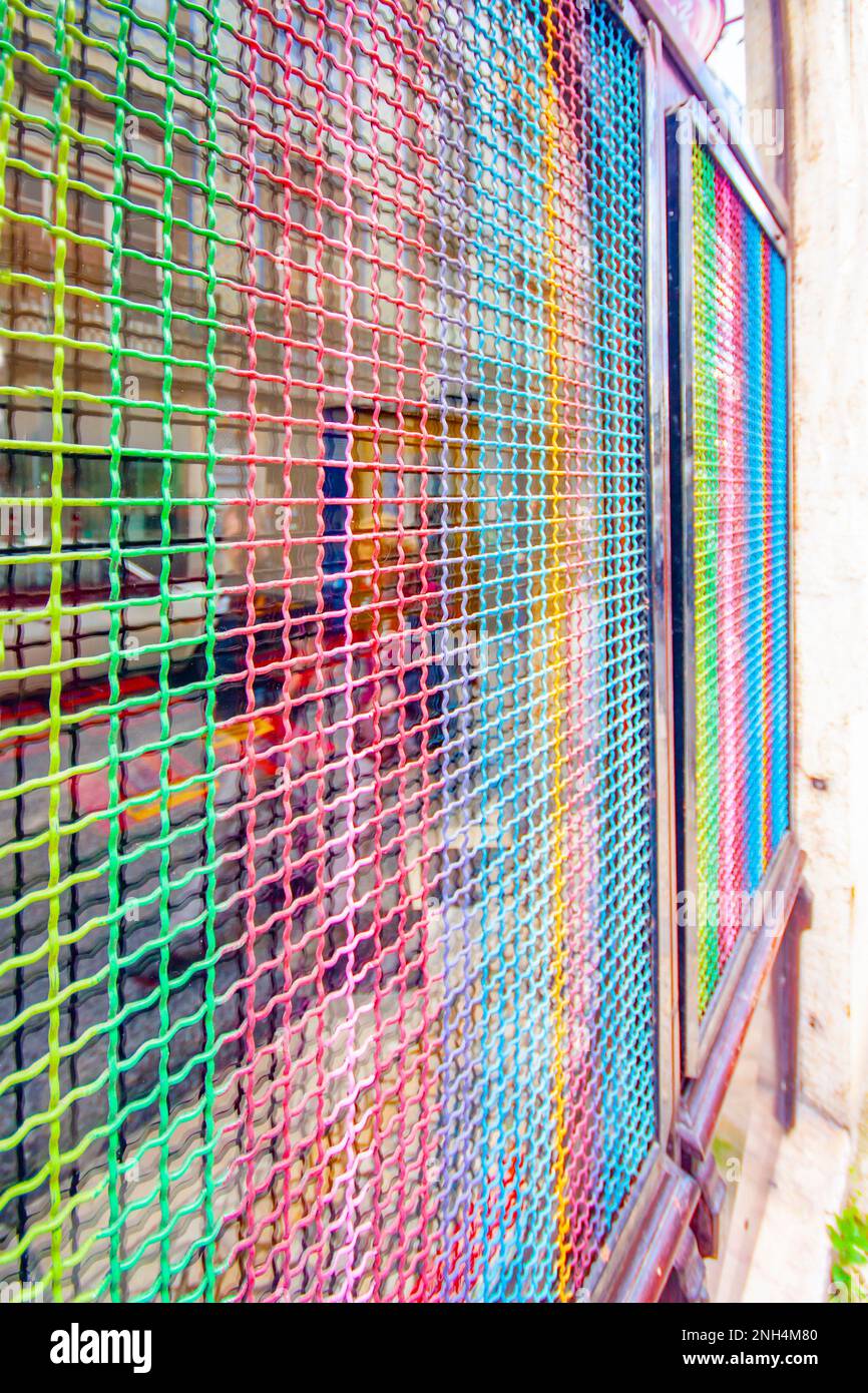 abstract metal grill with rainbow colours painted in Lisbon Portugal ...