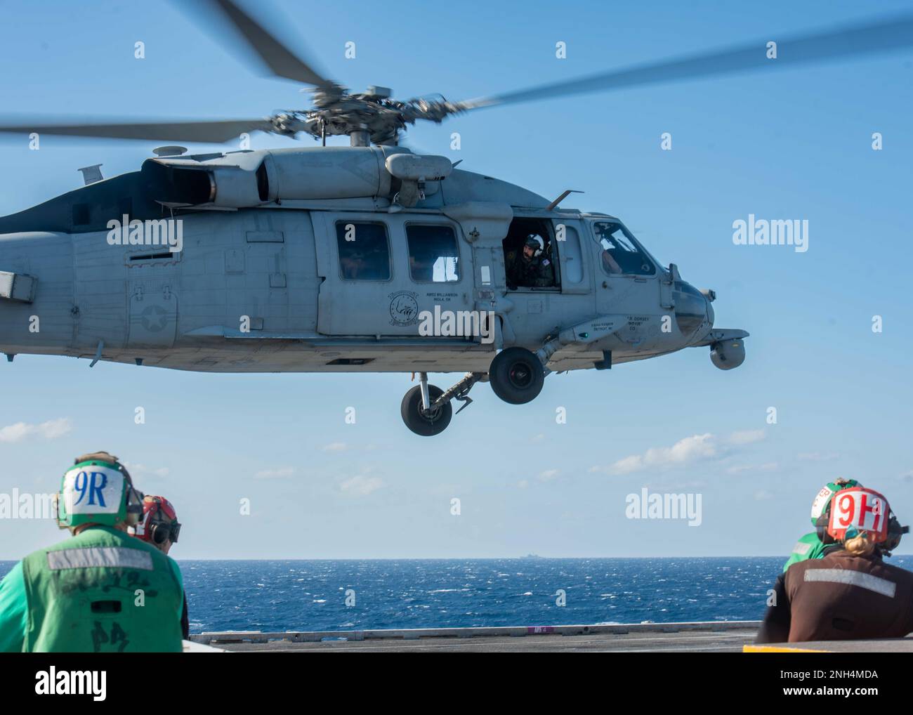 221213-N-UF592-1063 PHILIPPINE SEA (Dec. 13, 2022) Sailors observe as ...