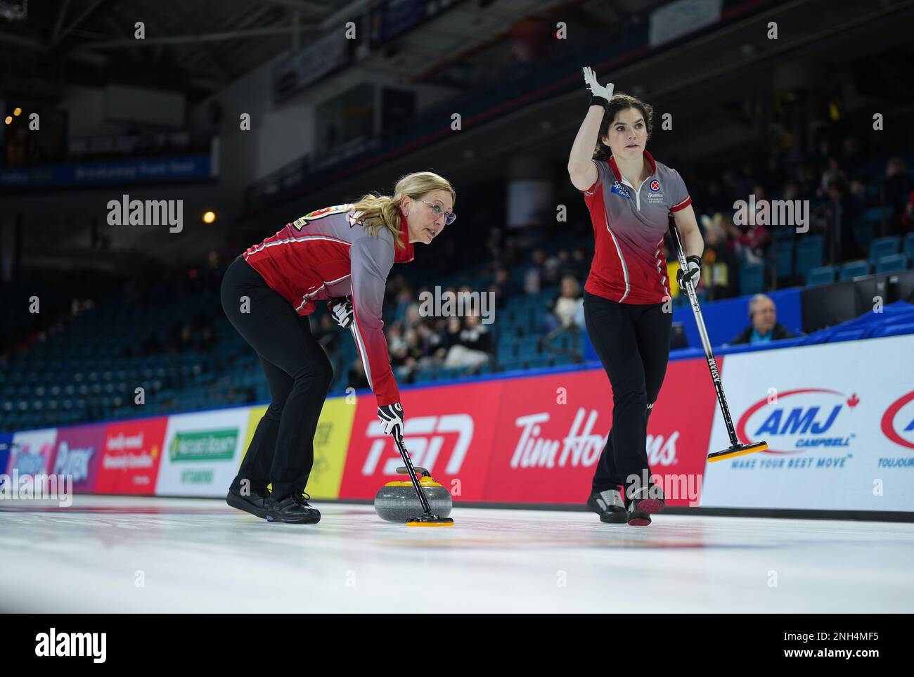 Northwest Territories fourth Jo-Ann Rizzo, left, sweeps as second Sarah ...