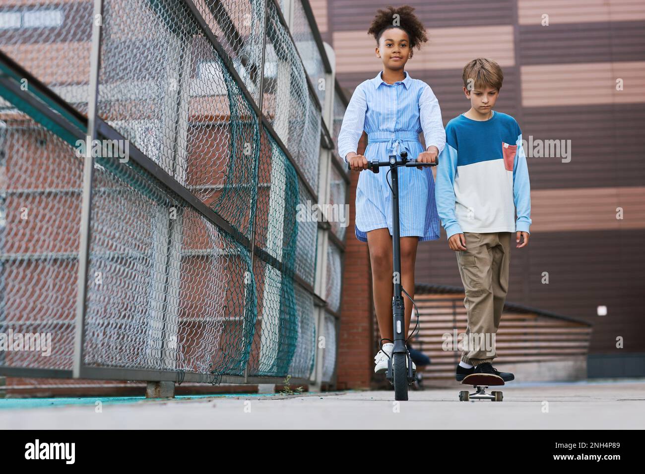 Schoolgirl riding a scooter hi-res stock photography and images - Alamy