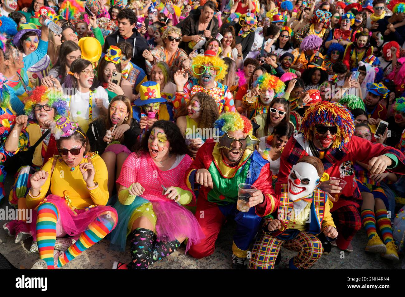 Revelers sit on the ground in a spontaneous mimic of the song lyric ...