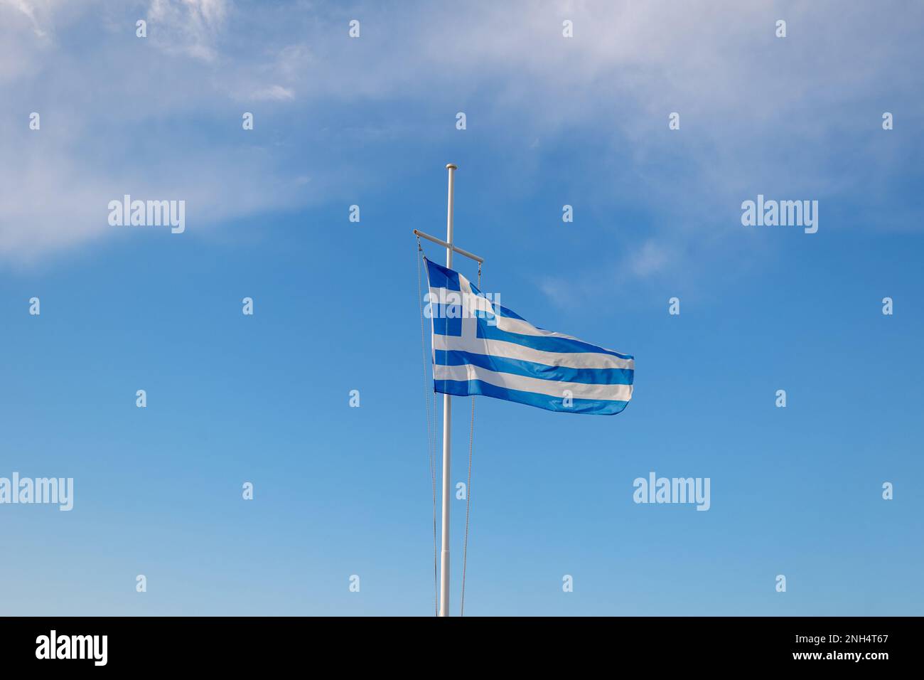 Greece flag is flying in air on blue sky background. Banner, place for ...