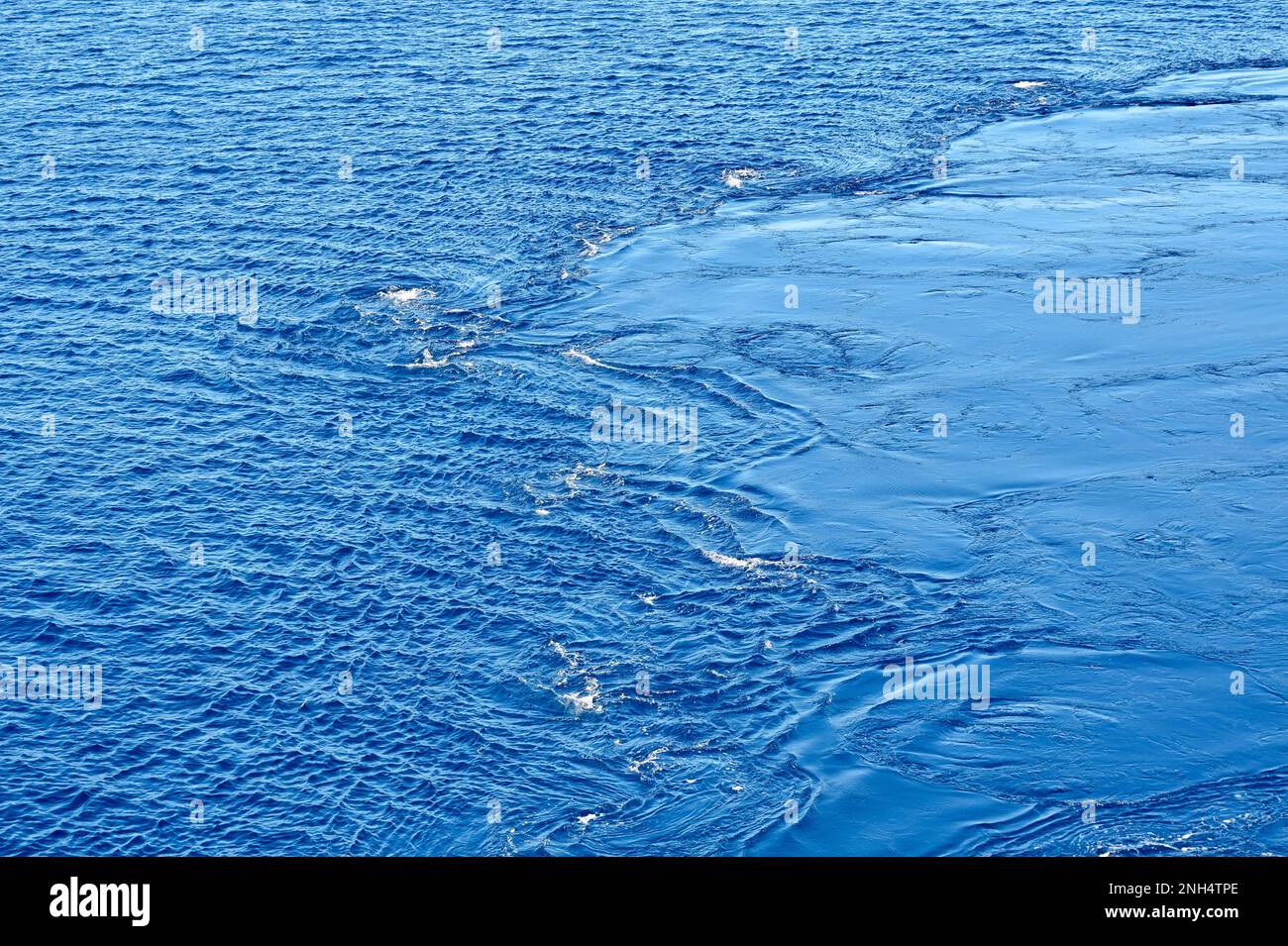 Pattern formed by swirling water in the sea from the propellers of a ...