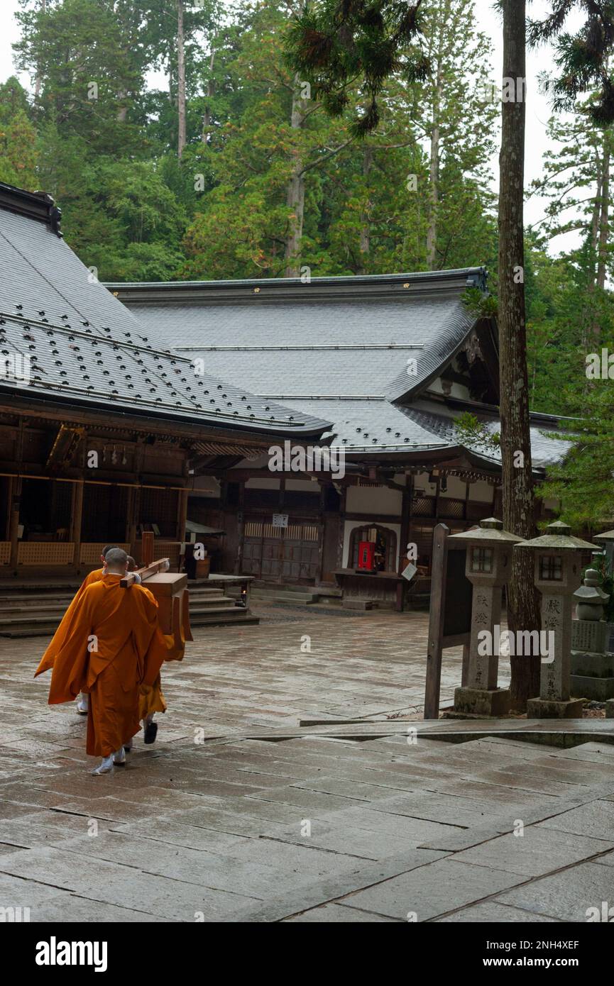 Monks in saffron robes carrying the offering chest, Mount Koya, Japan ...