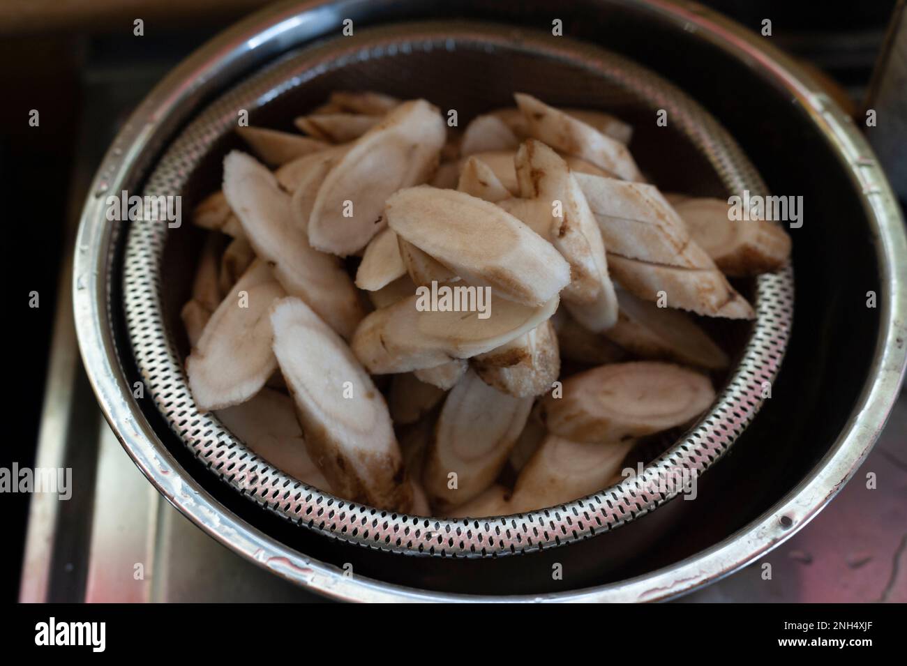 Preparing burdock root, a Japanese vegetable, for the Osechi Ryori ...