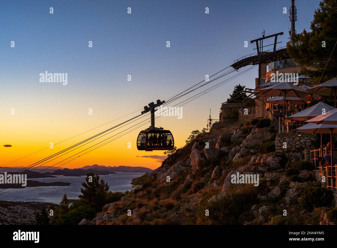 View of Dubrovnik cable car ascending at sunset just before arriving at ...