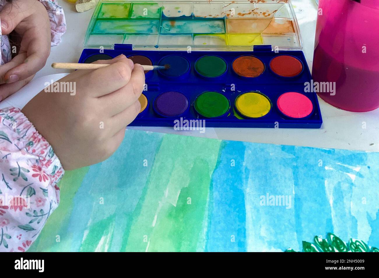 Young girl painting during art class at school Stock Photo - Alamy