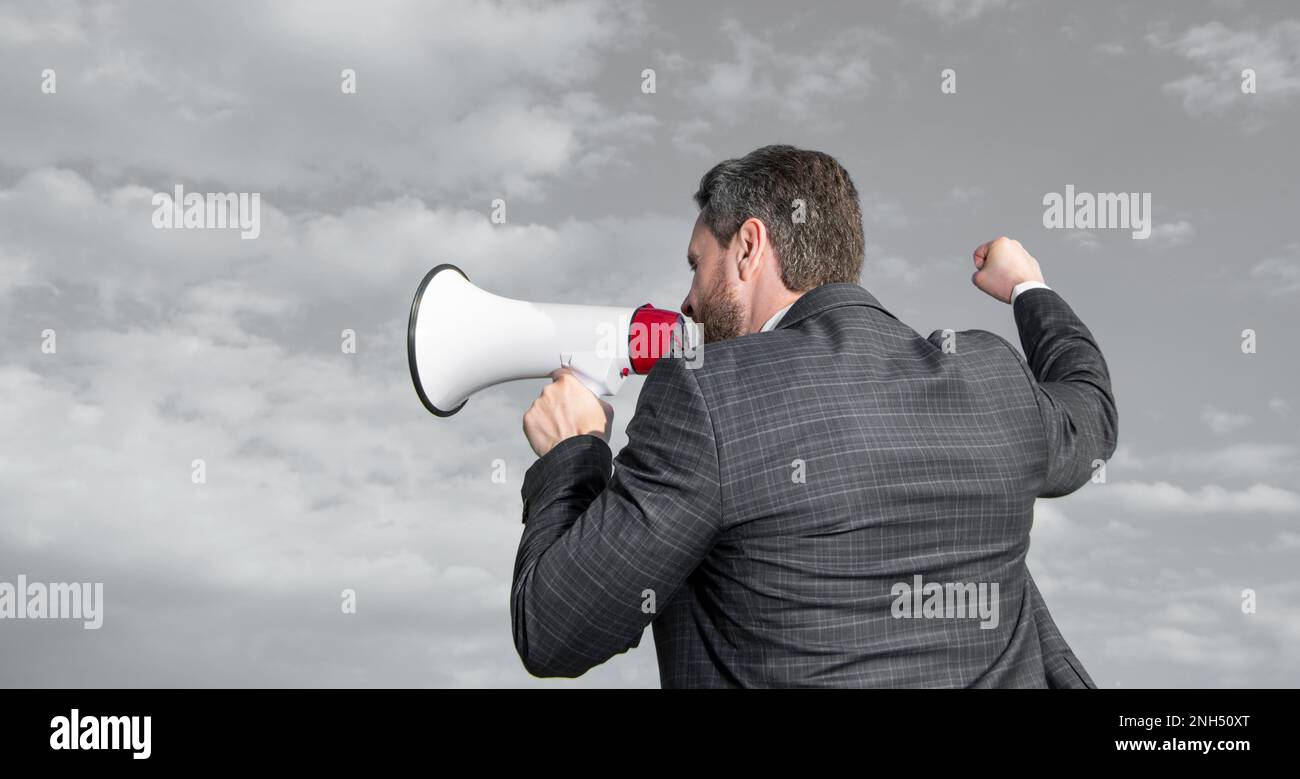 back view of businessman shout in loudhailer on sky background Stock ...