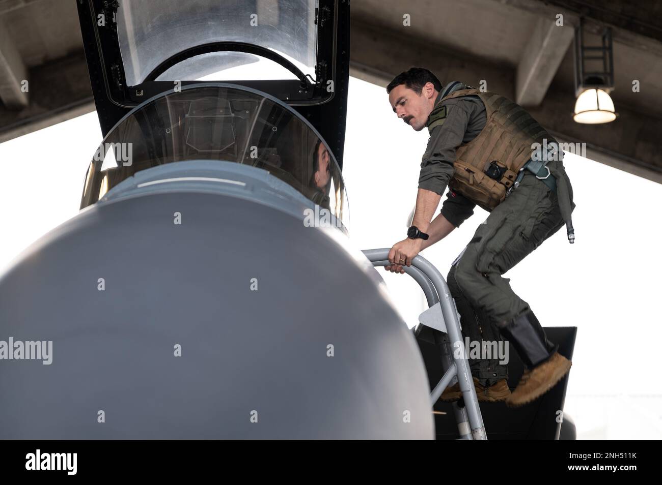 A U.S. Air Force pilot assigned to the 44th Fighter Squadron climbs ...