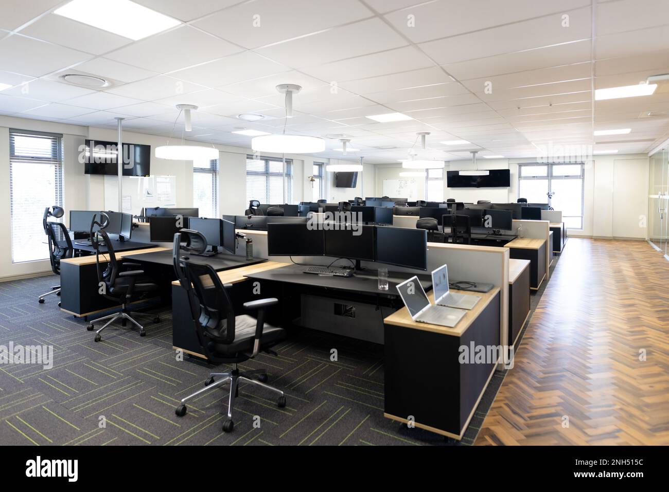 Empty creative modern office room with desks and computers Stock Photo ...