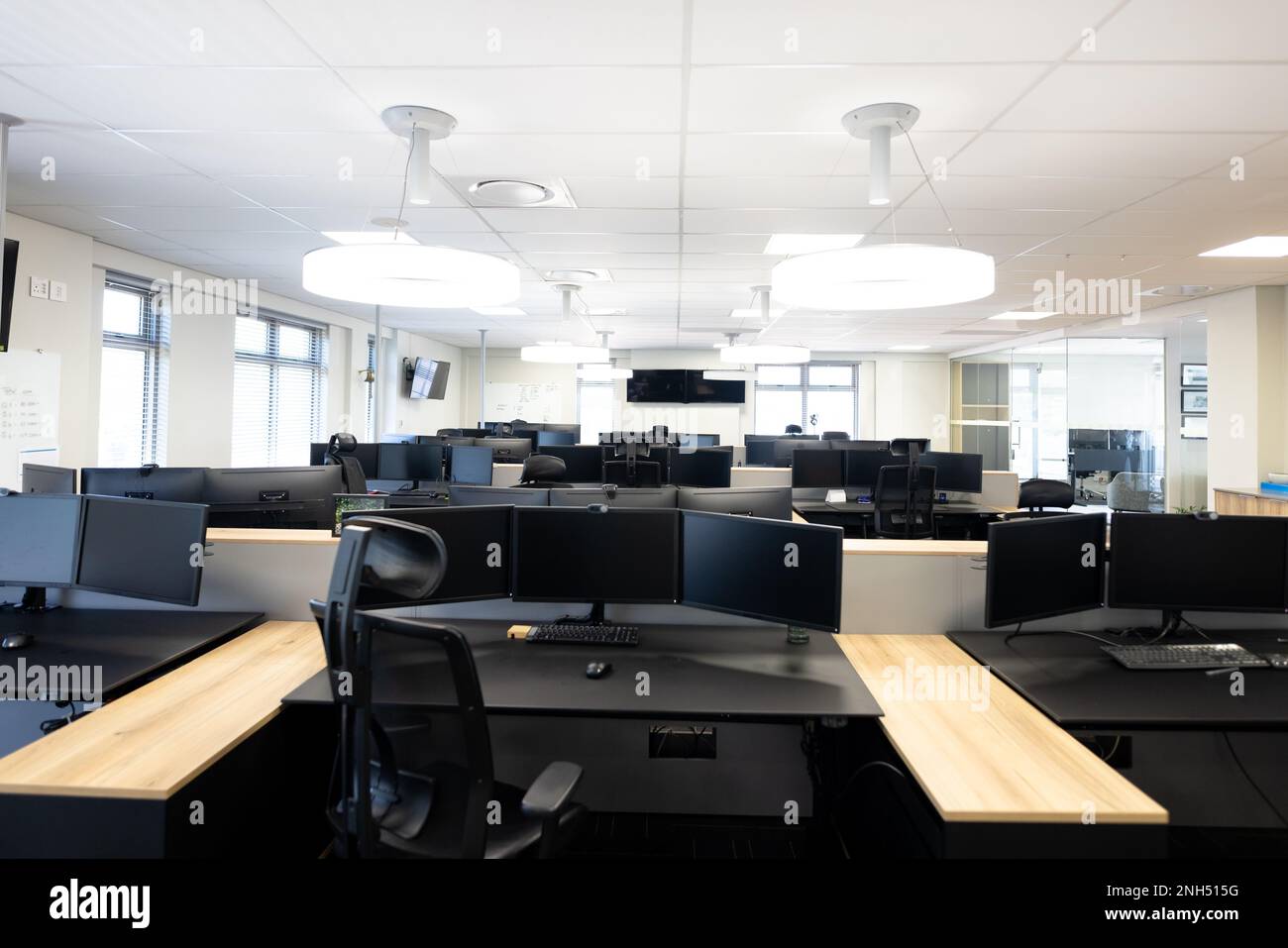 Empty creative modern office room with desks and computers Stock Photo ...