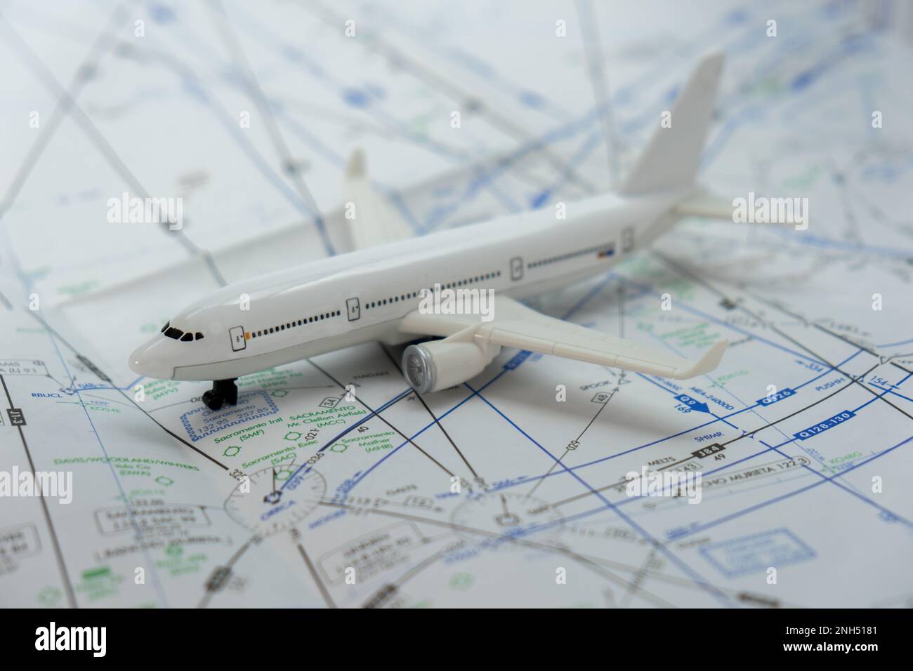 Close up of airplane sitting on an FAA navigation aid sectional chart ...