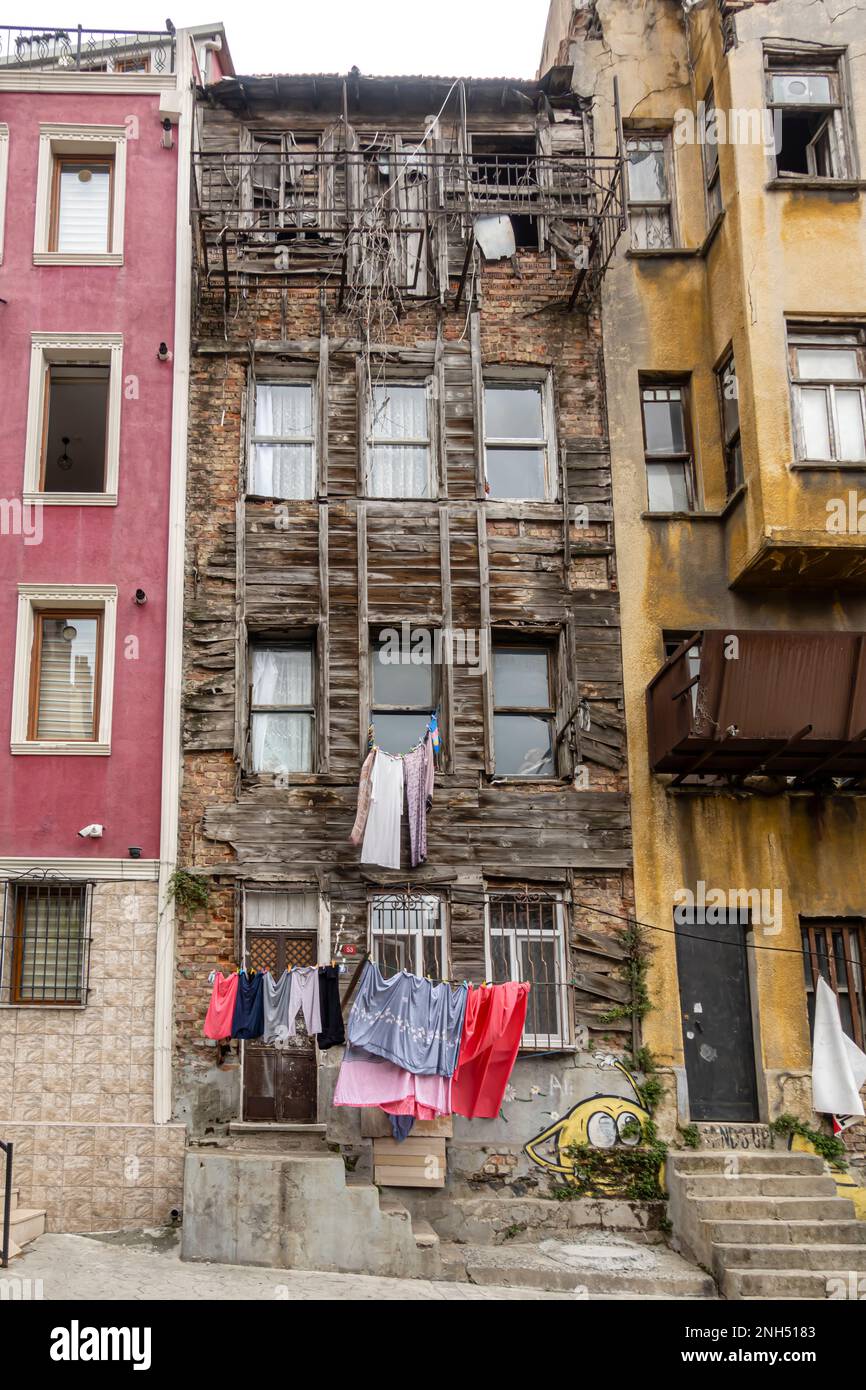 Wooden delapidated building house with clothes drying on wires. Old ...