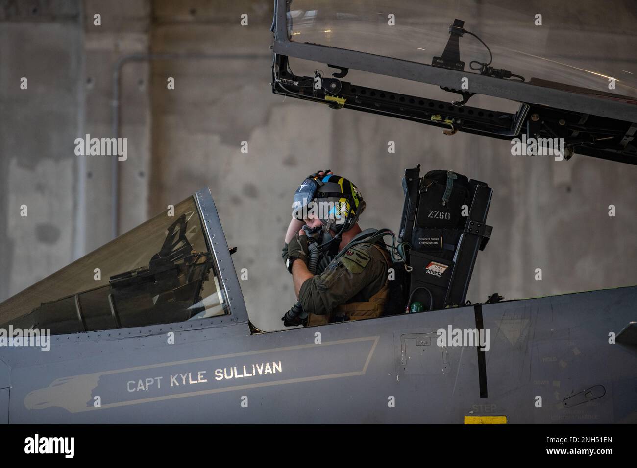 A 44th Fighter Squadron pilot adjusts his helmet pre-flight at Kadena ...