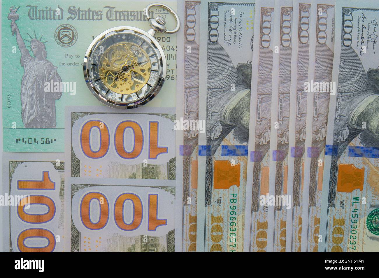 US Treasury check, hundred dollar bills in a layout with a modern ...