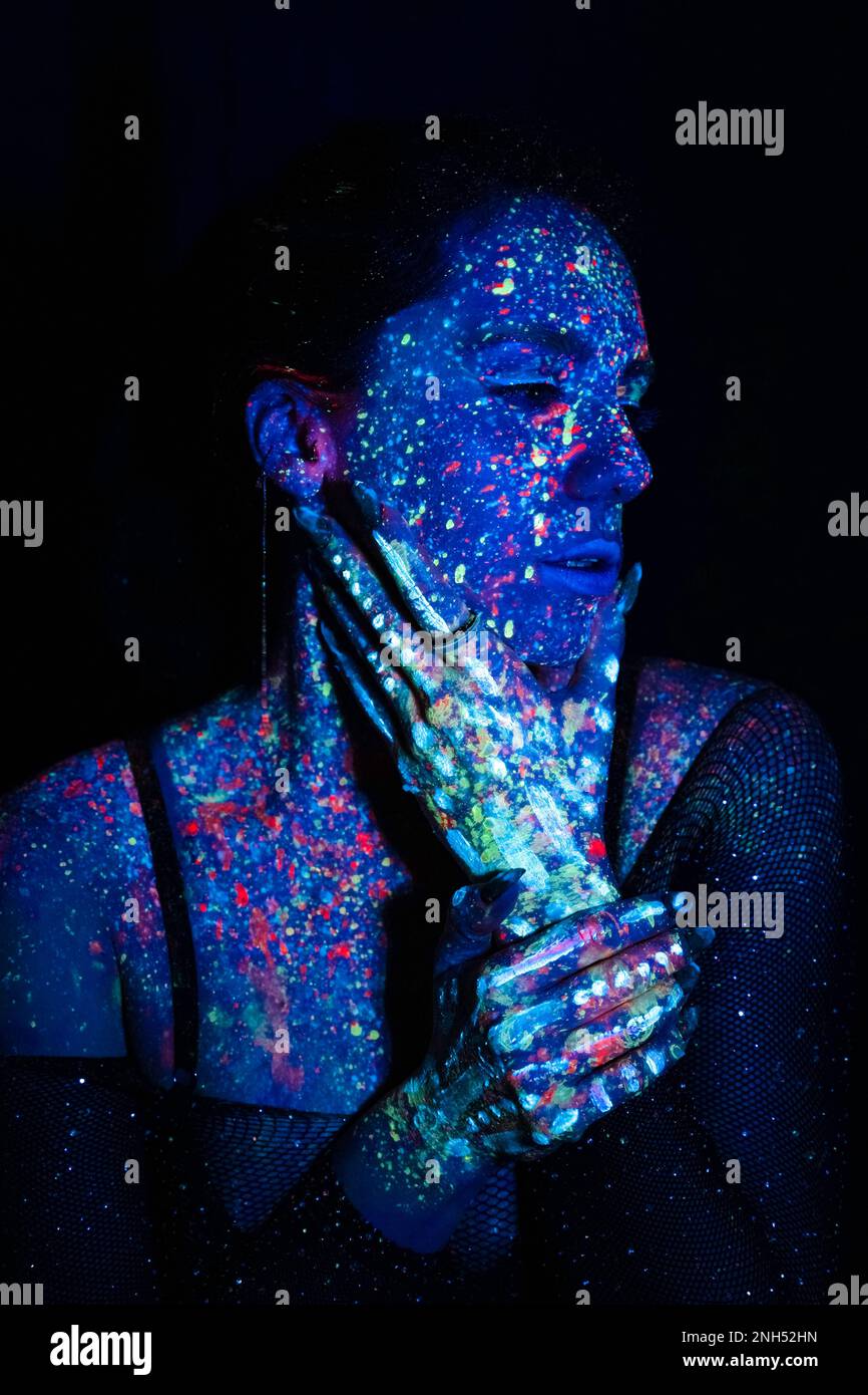 Portrait of a beautiful woman with blue sequins on her face. Girl with ...