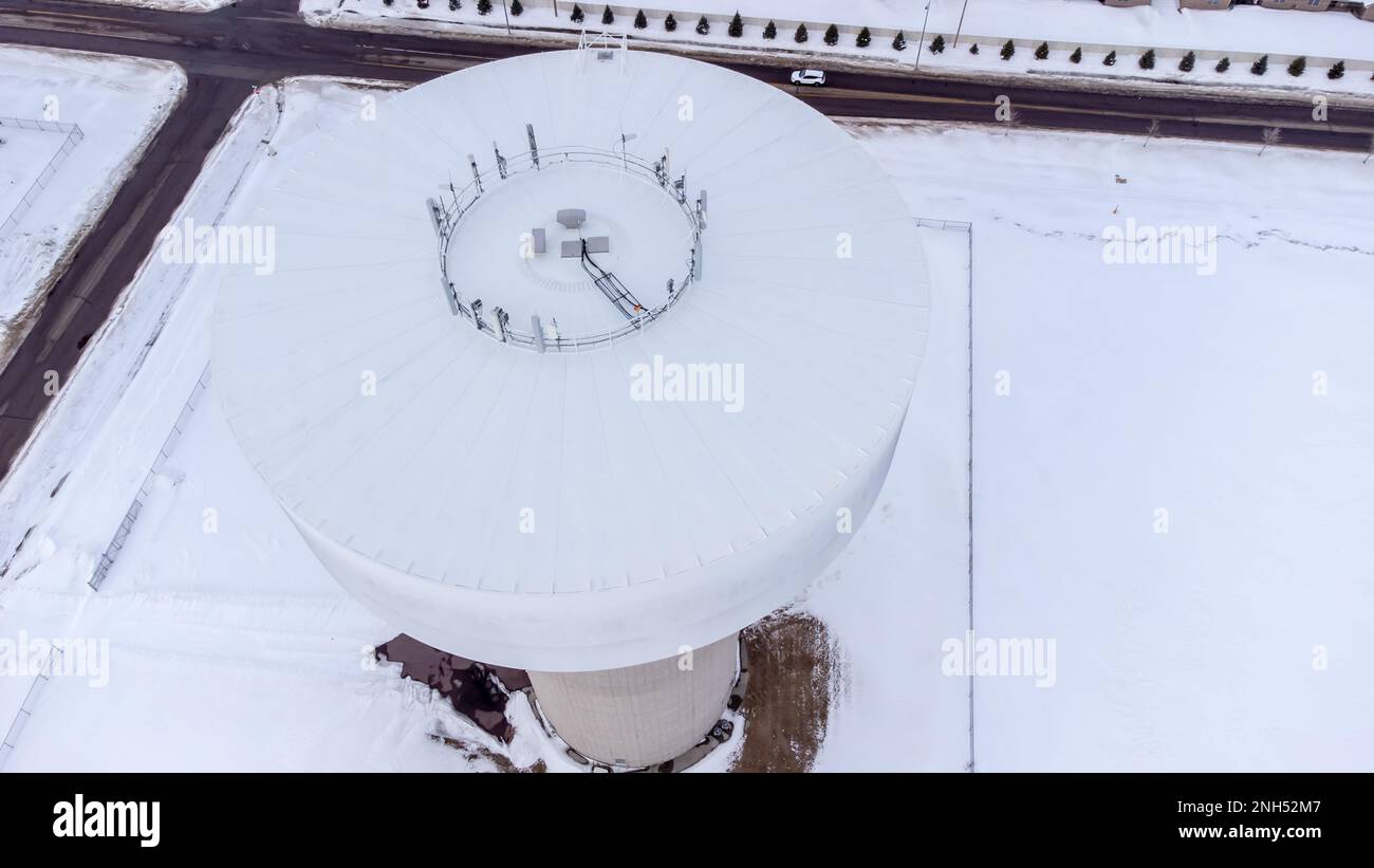 Drone overhead view of a water tower with communications antennae ...