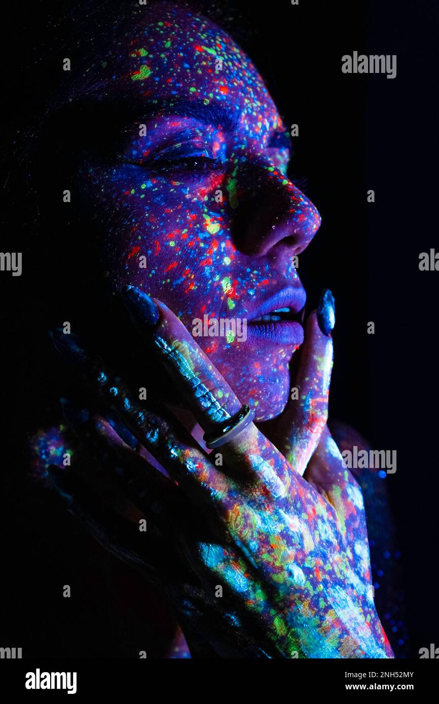 Model woman in neon light, beautiful model girl with fluorescent makeup ...
