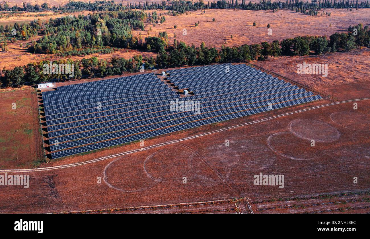 solar power station on a field with scorched grass in the foreground ...