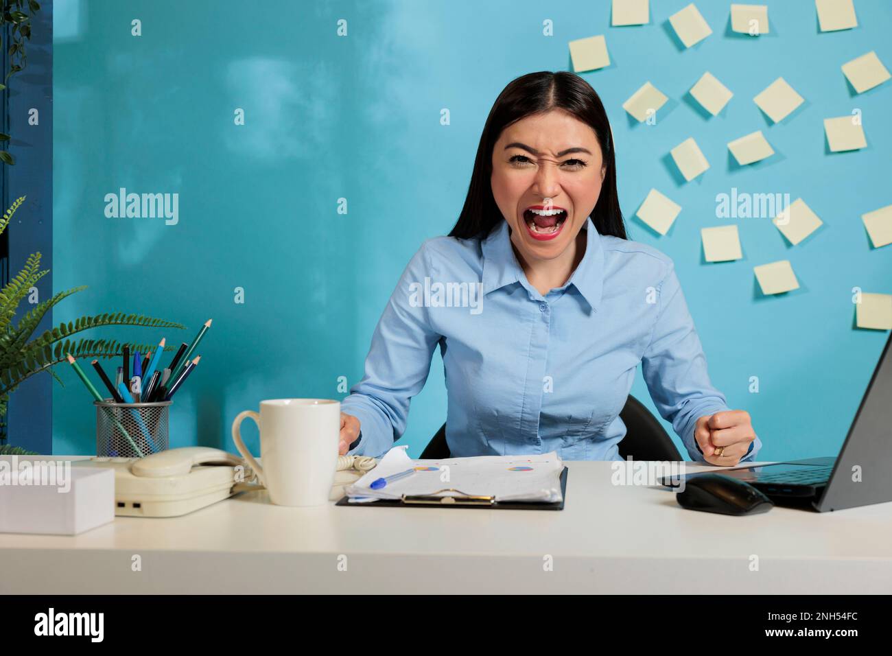 Overworked female corporate employee expressing desperation and stress ...