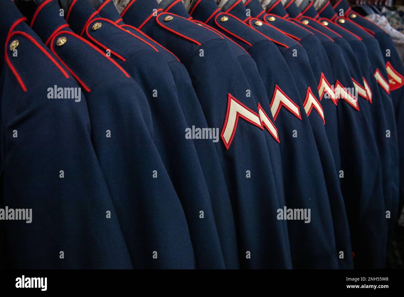 Dress Blue jackets hang on a rack during an initial uniform fitting for ...