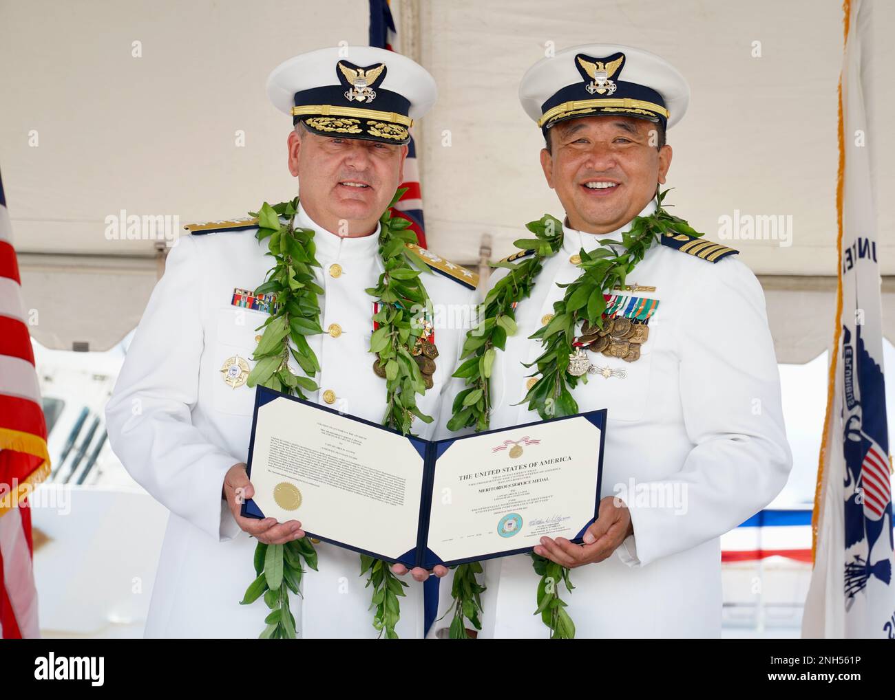 Rear Adm. Michael Day presents a departing award to Capt. Arex Avanni ...
