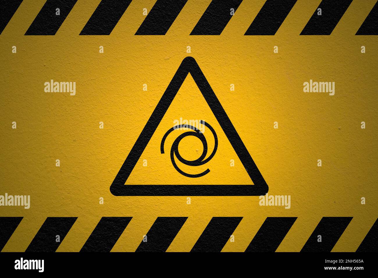Black striped yellow background with a Automatic start up warning sign ...