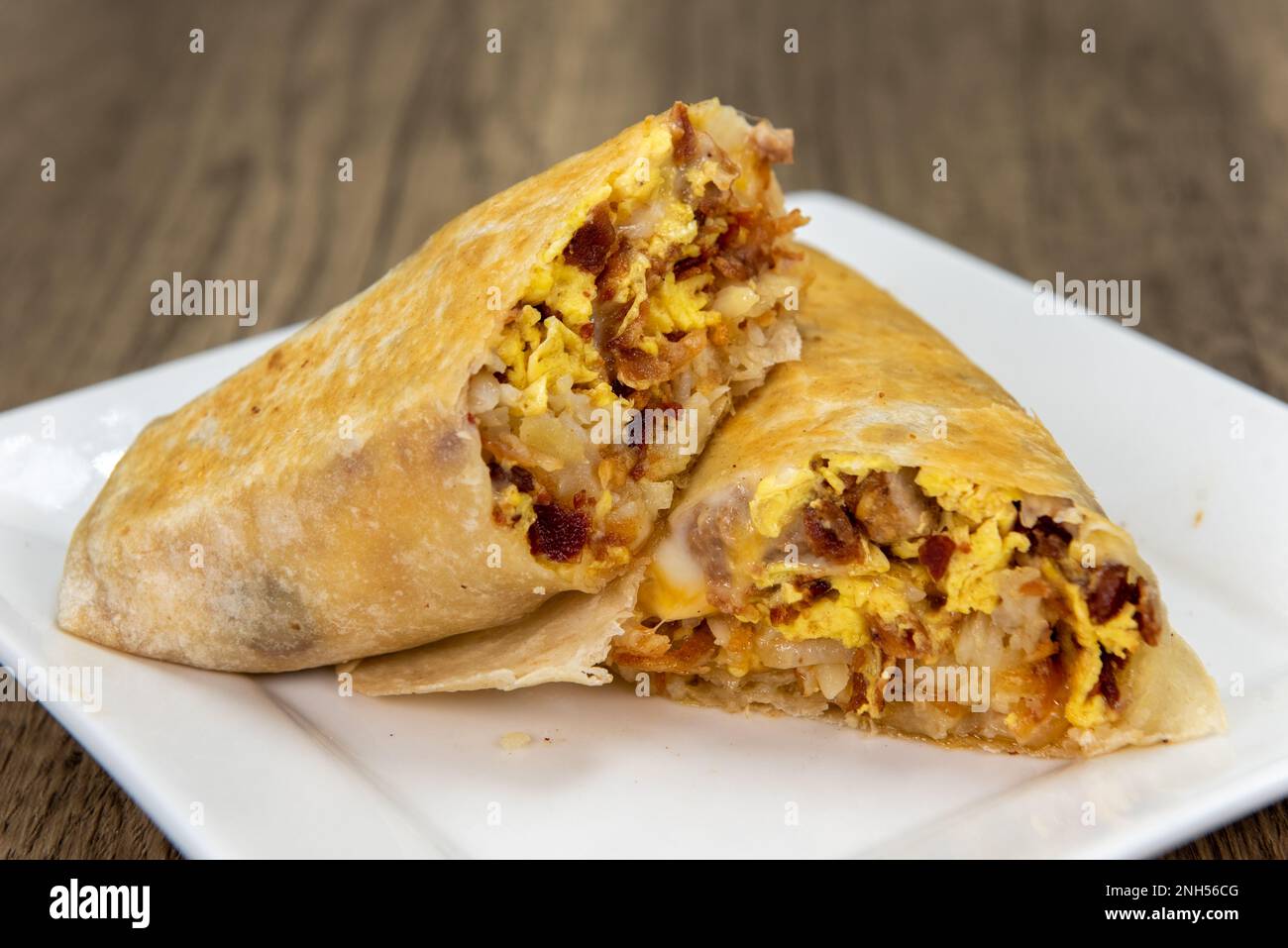 Traditional breakfast burrito with eggs, potatoes, salsa, and cheese ...