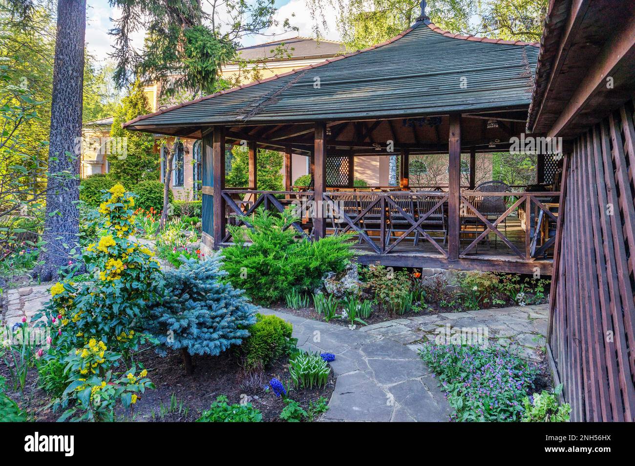 big pavilion for barbeque and wonderful plants in garden near cottage ...