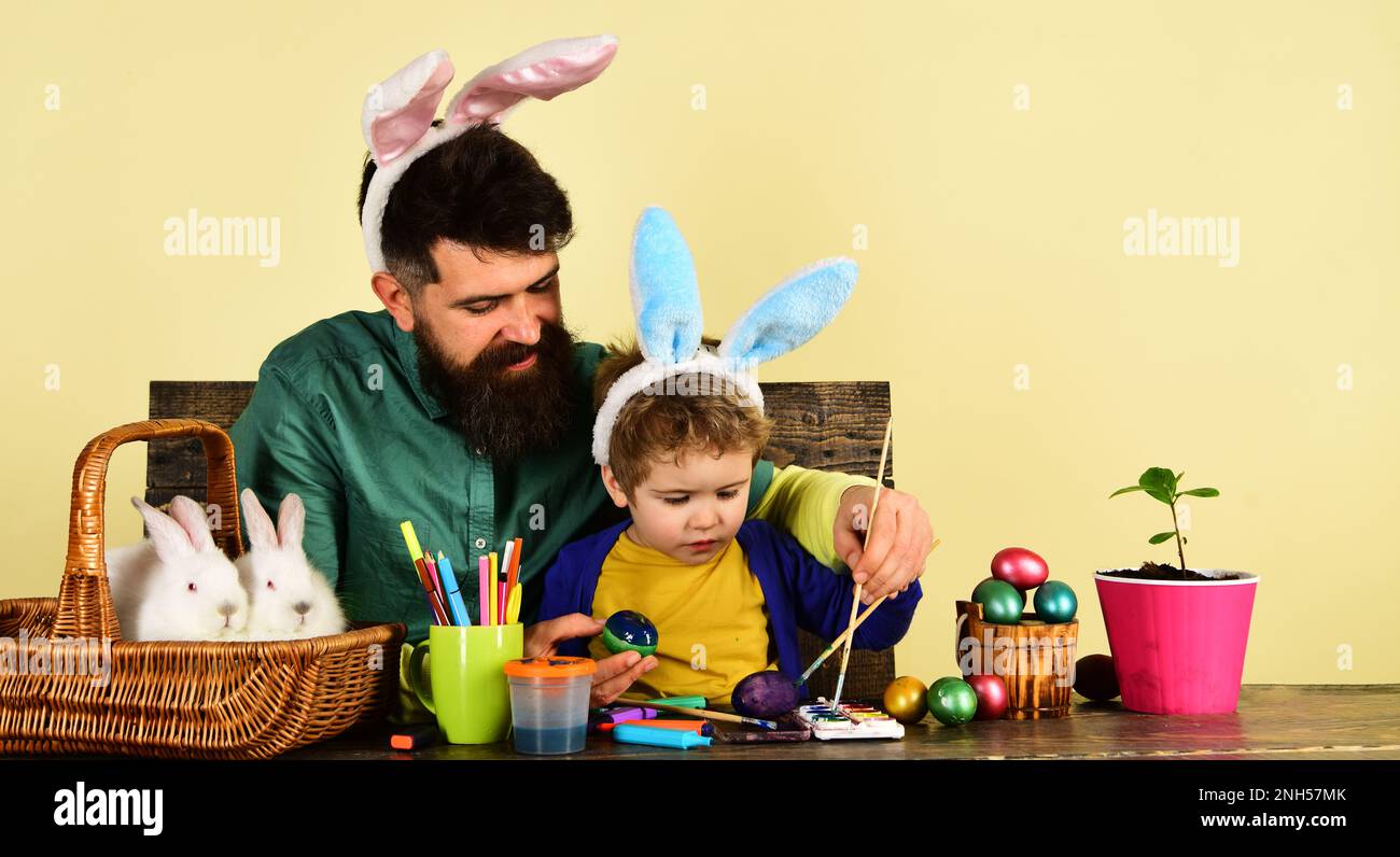 Father and son painting Easter eggs. Cute little child boy wearing ...