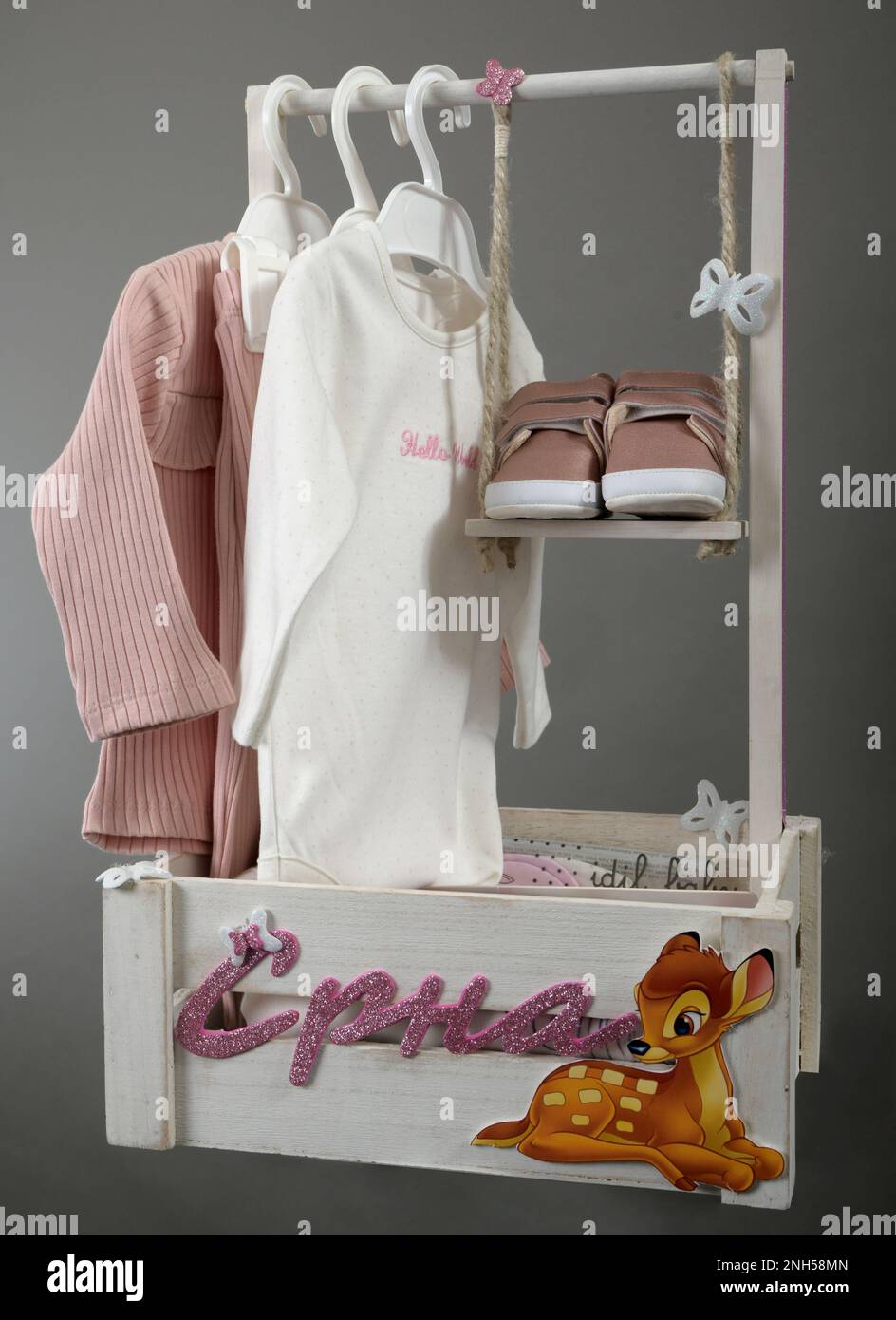A gift for a newborn baby, placed in a small wooden crate, the shoes ...