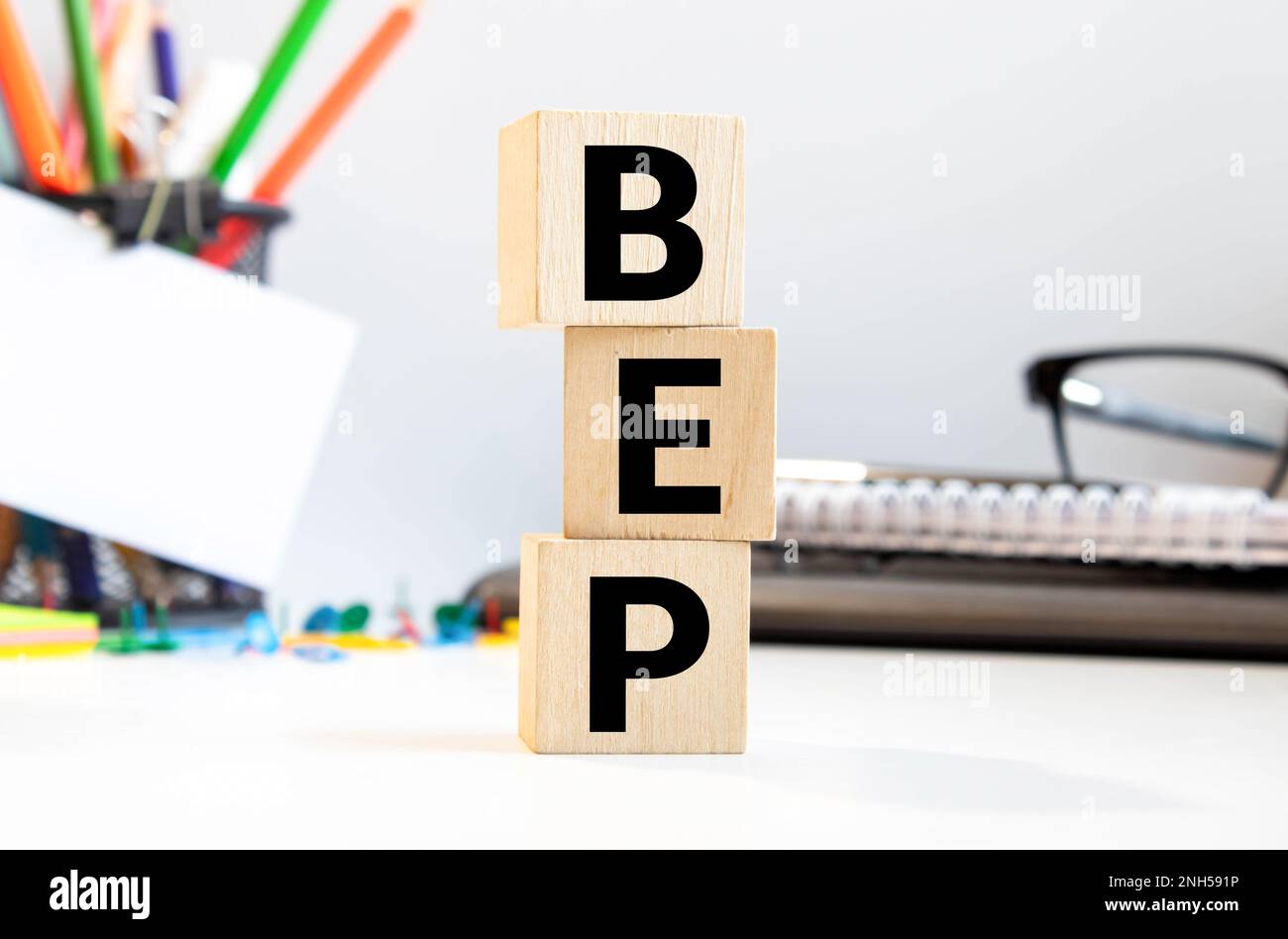 Word BEP. Wooden small cubes with letters isolated on blur background ...