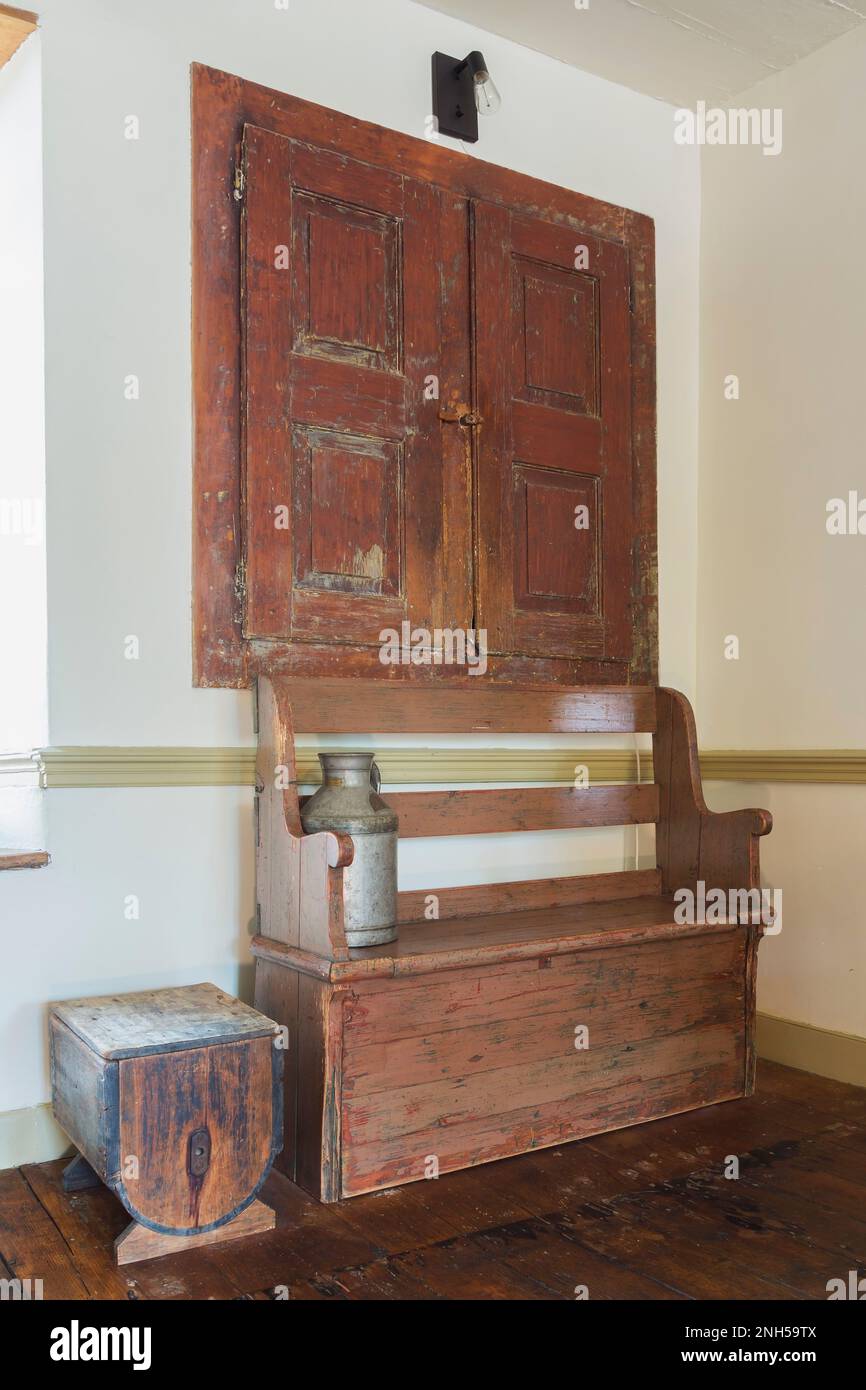 Antique wooden sitting and storage bench in corner of dining room with ...