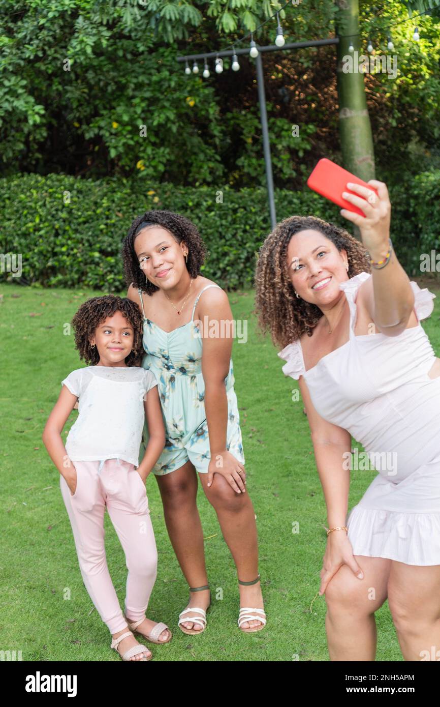 mother taking a selfie with her daughters outdoors Stock Photo - Alamy