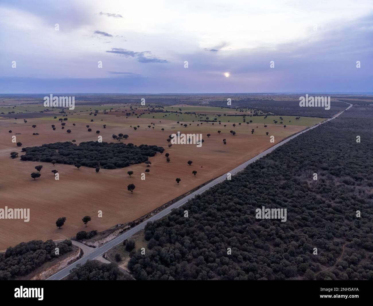 aerial image of a local road, with plowed crop fields with spread holm ...