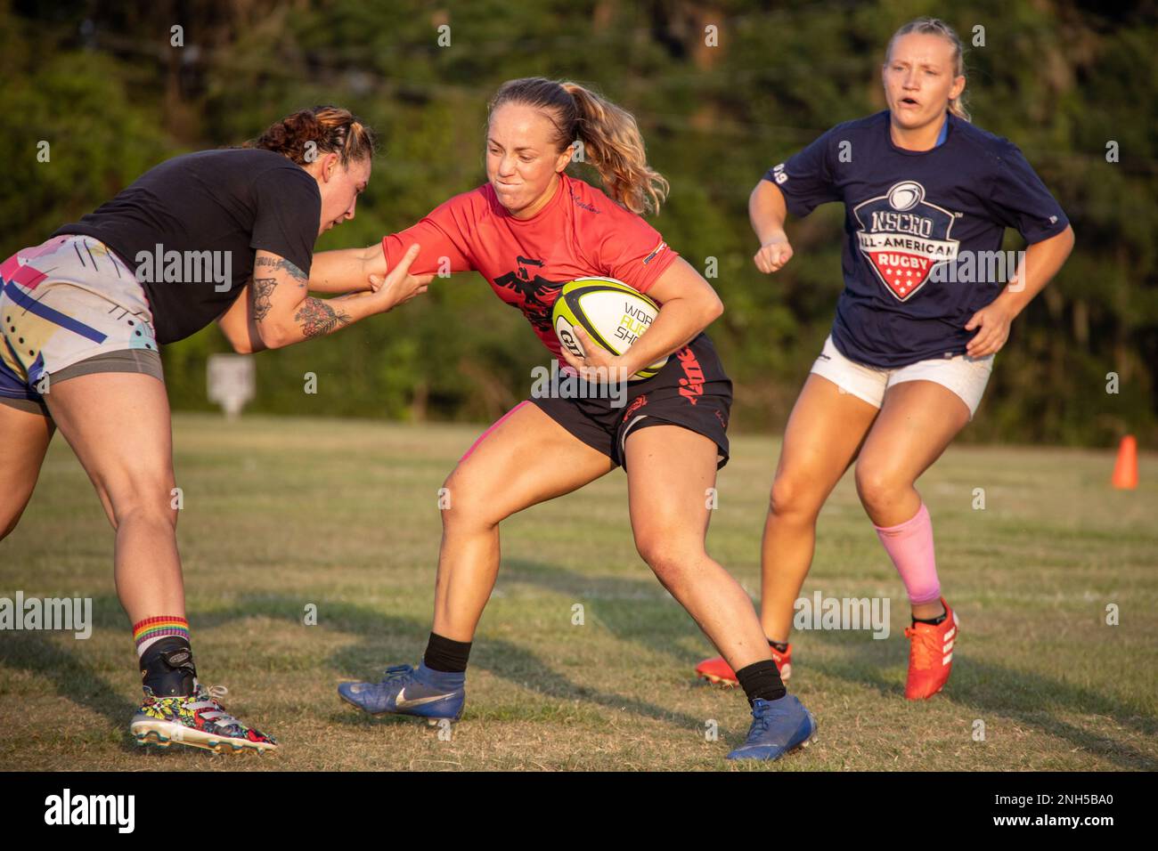 U.S. Marine 2nd Lt. Audrey Hollis, center, USMC Rugby Team member ...