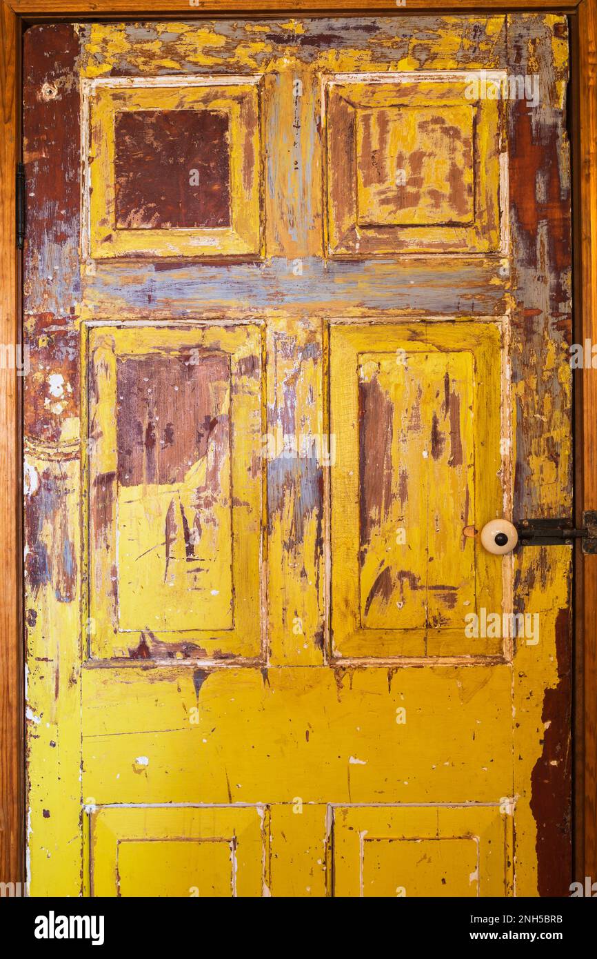 Distressed yellow painted wooden closet door in upstairs guest bedroom ...
