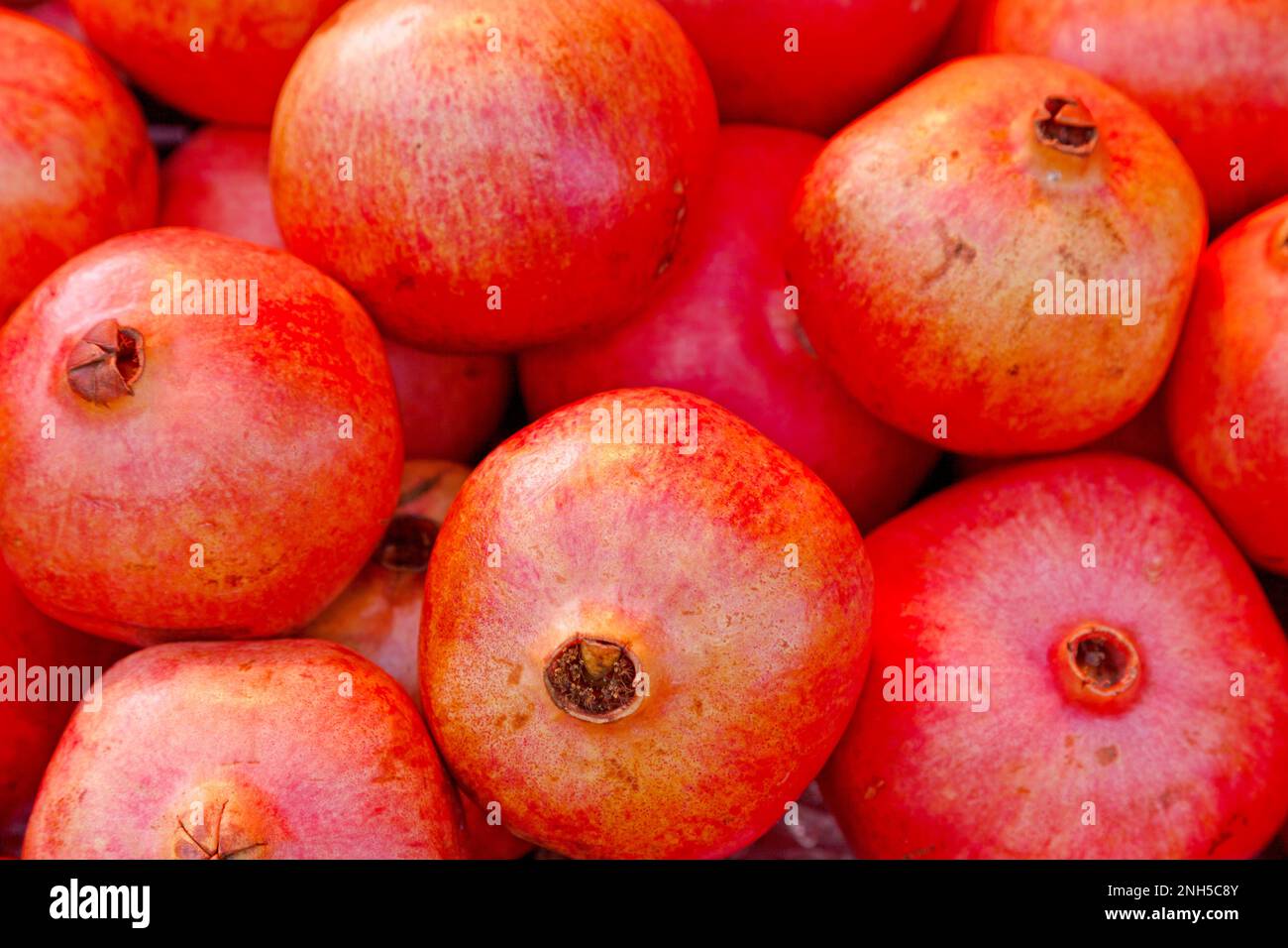 Close-up on a stack of pomegranates for sale a market stall Stock Photo ...